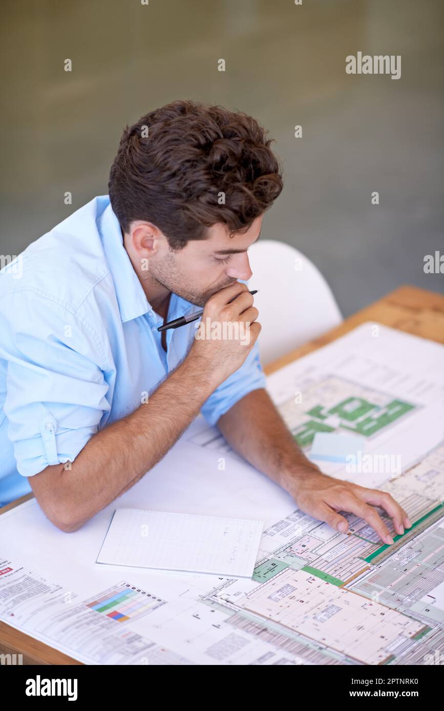 Its the perfect building. a handsome young architect reviewing ...