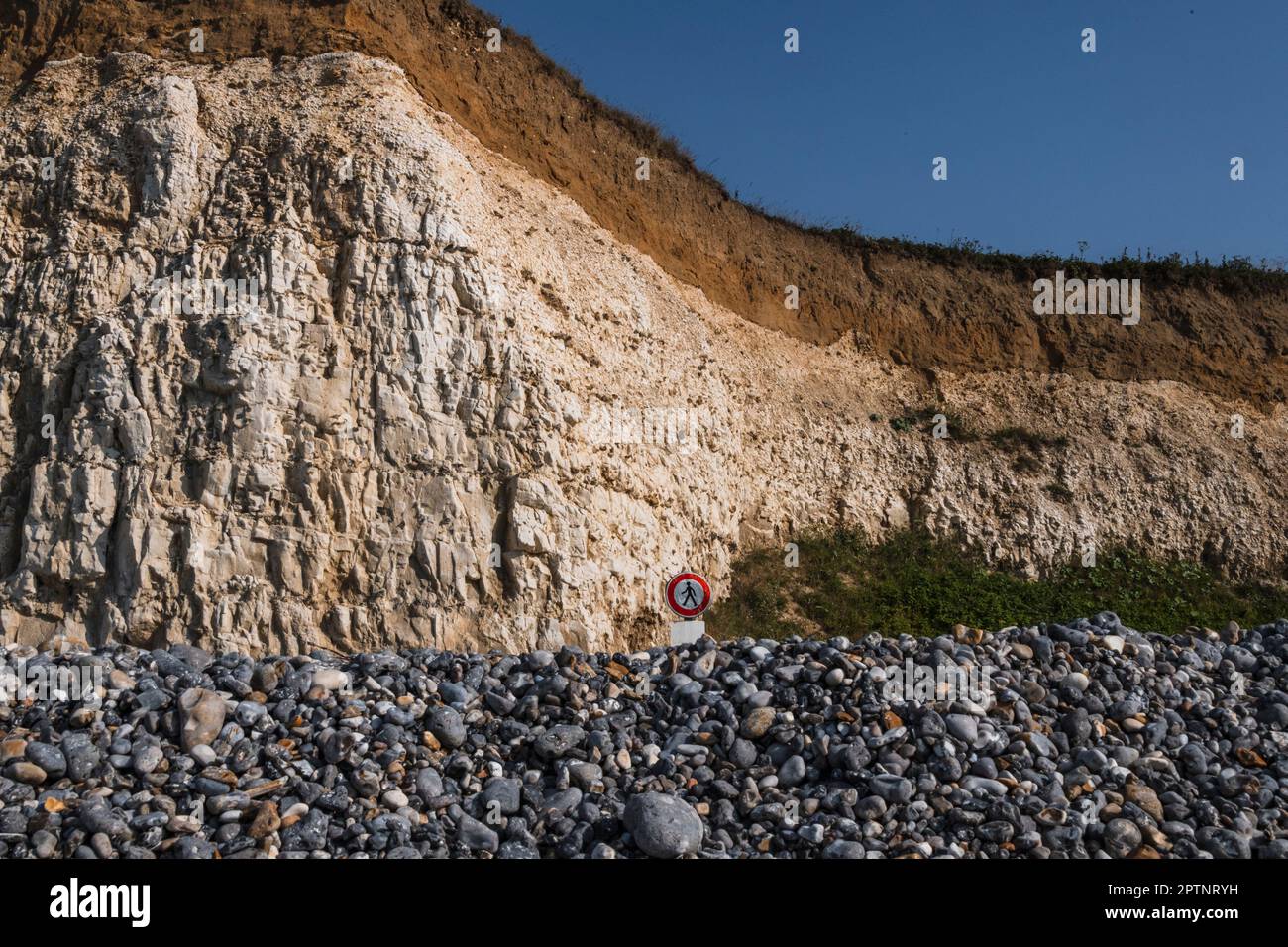 Cliff with a no-walking sign due to the risk of rockfall Stock Photo ...