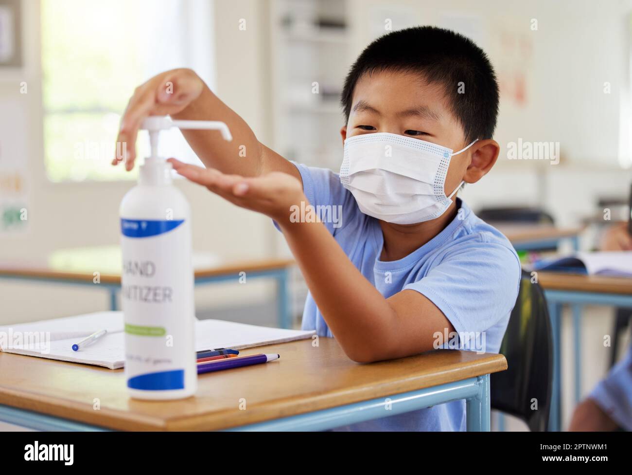 Covid, hand sanitizer and school student with mask cleaning, protecting ...