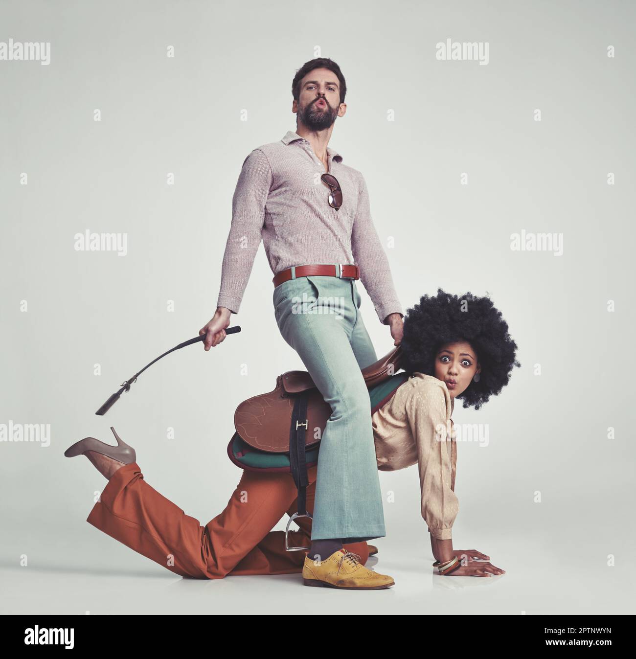 Hes in charge now. A studio shot of an attractive man in 70s wear ...