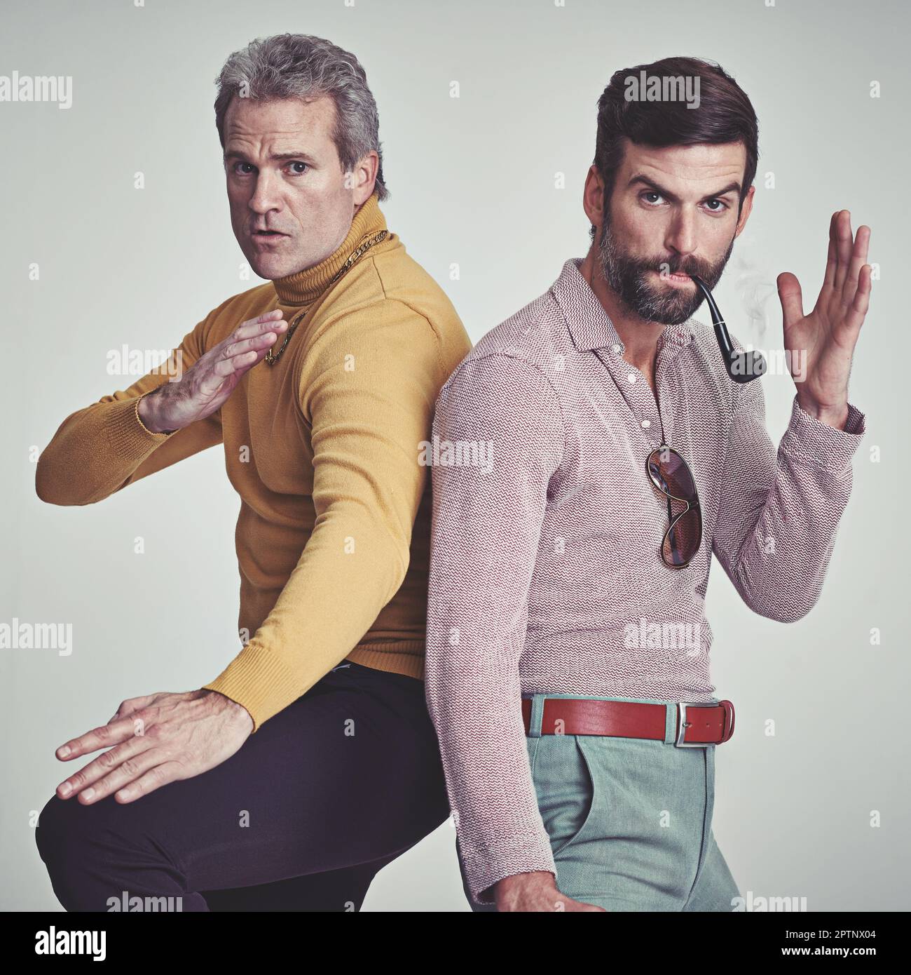 No one puts baby in a binder. Studio shot of two men standing together ...