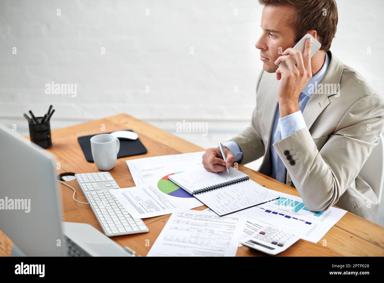 Relaying important info to his clients. a young businessman talking on ...