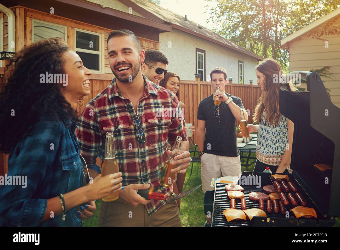 Nice to meat you...a group of friends having a barbecue outside Stock ...
