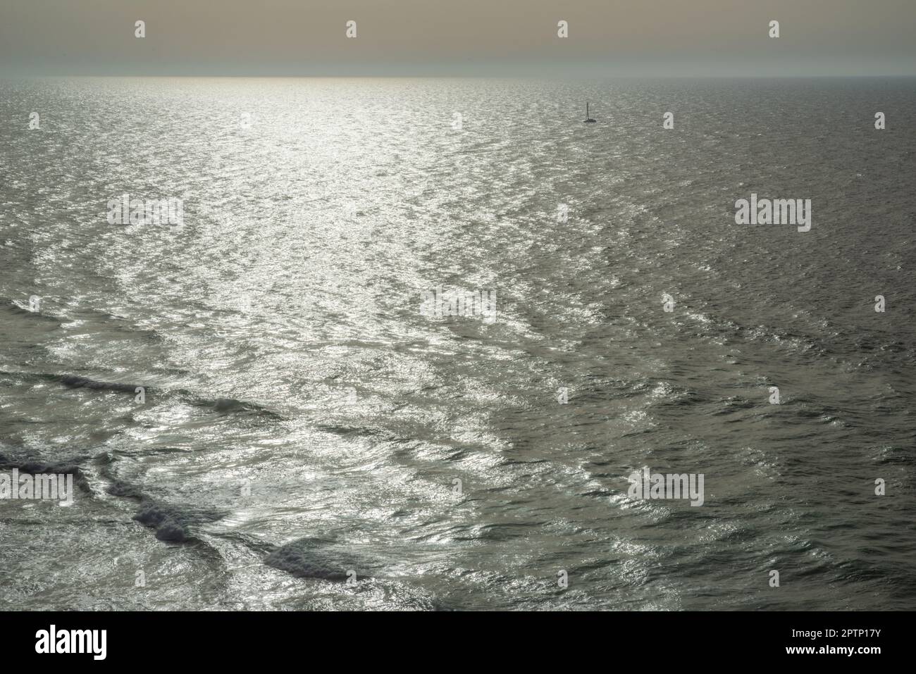 Glittering ocean water surface and small boat in some distance Stock ...