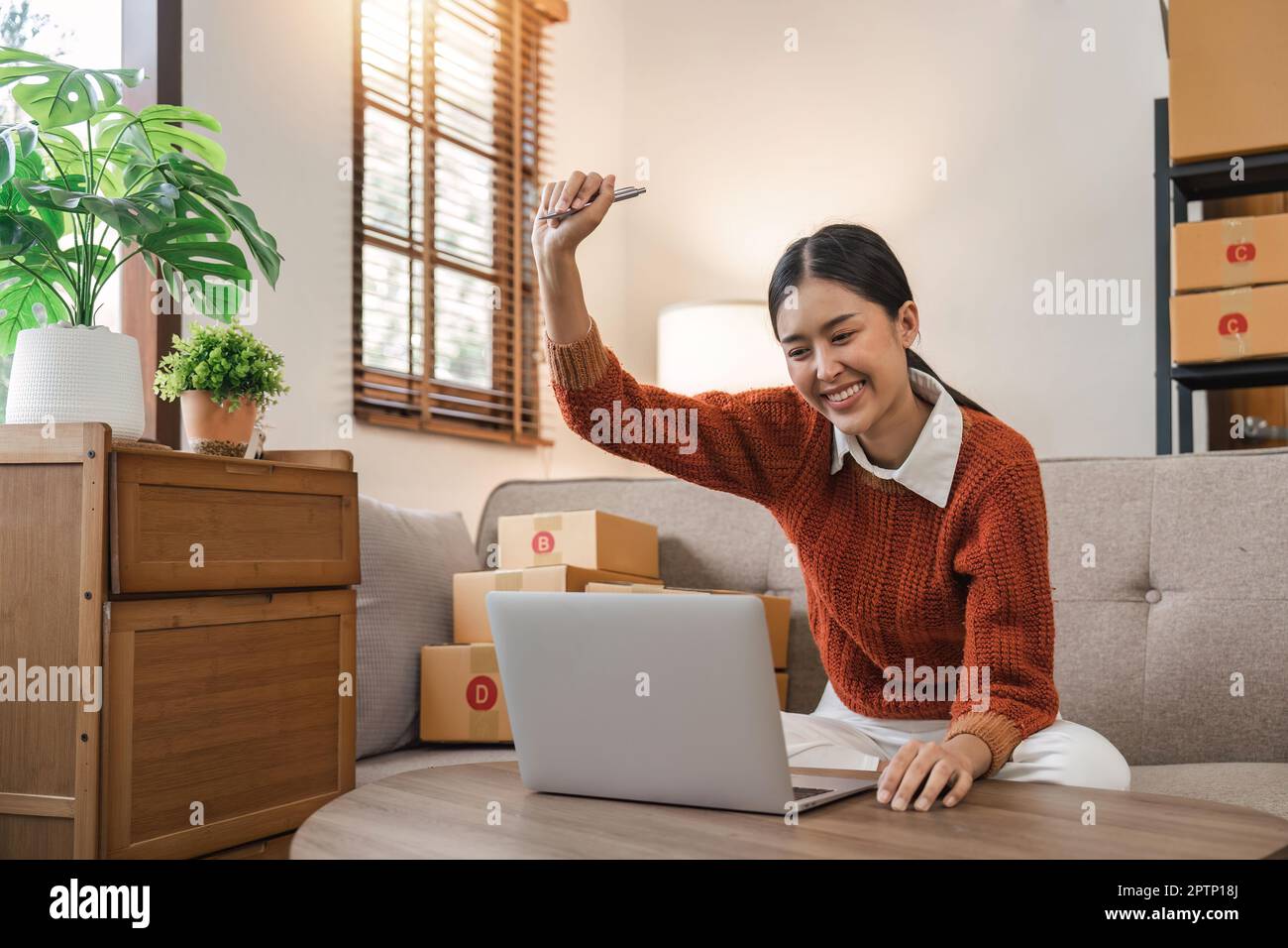 Happy successful small business owner celebrating her highest sales ...