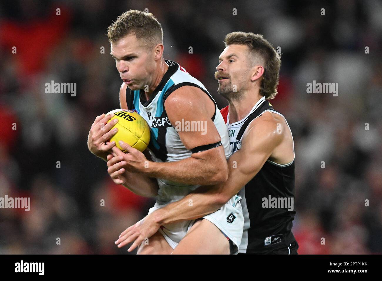 Dan Houston of Port Adelaide (left) marks the footy during the AFL ...
