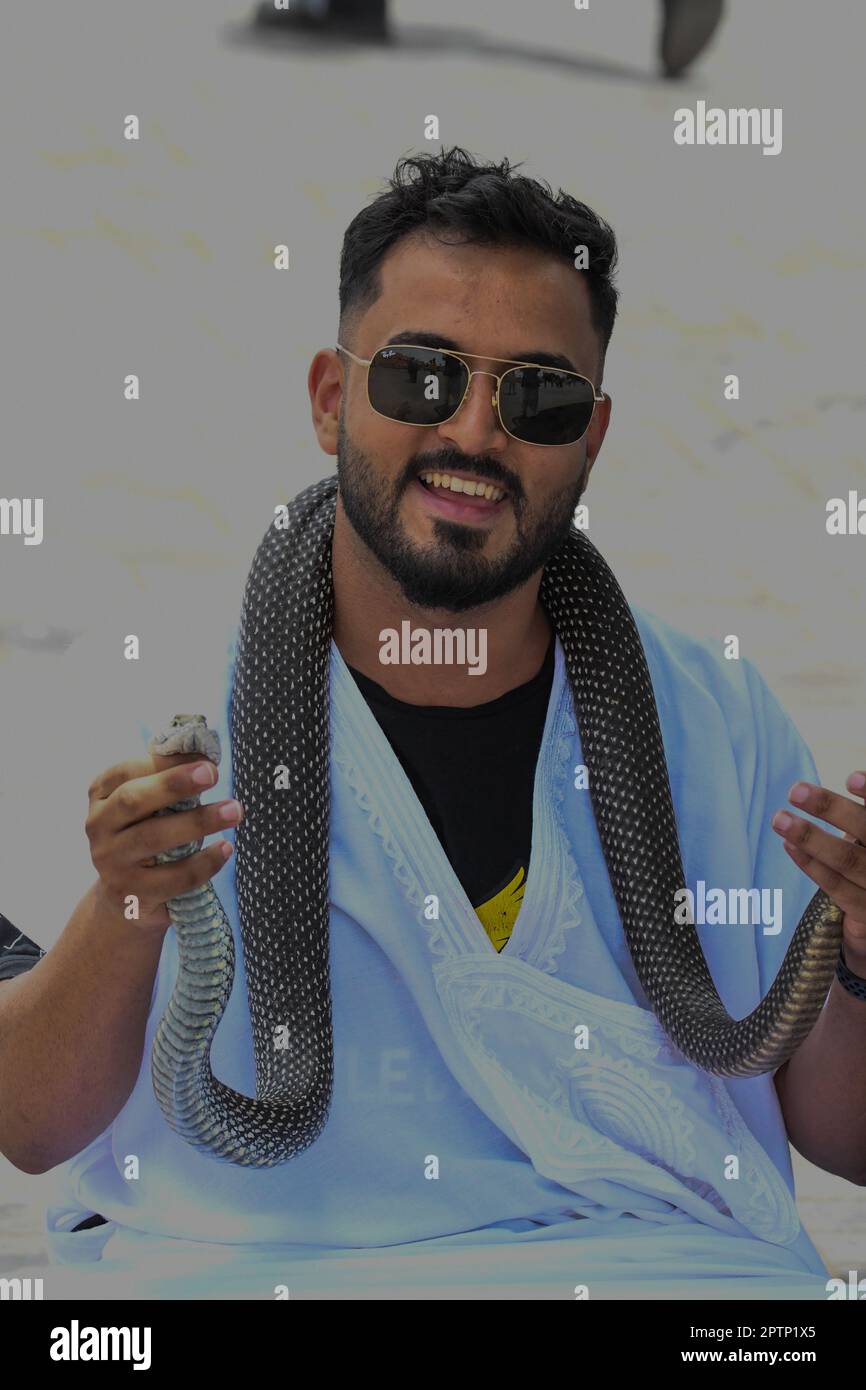 Snake on Arab man shoulders Stock Photo - Alamy