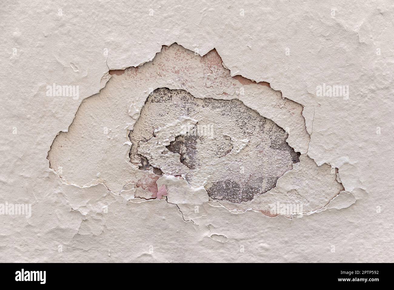 Full frame house facade closeup including a spot with white broken ...