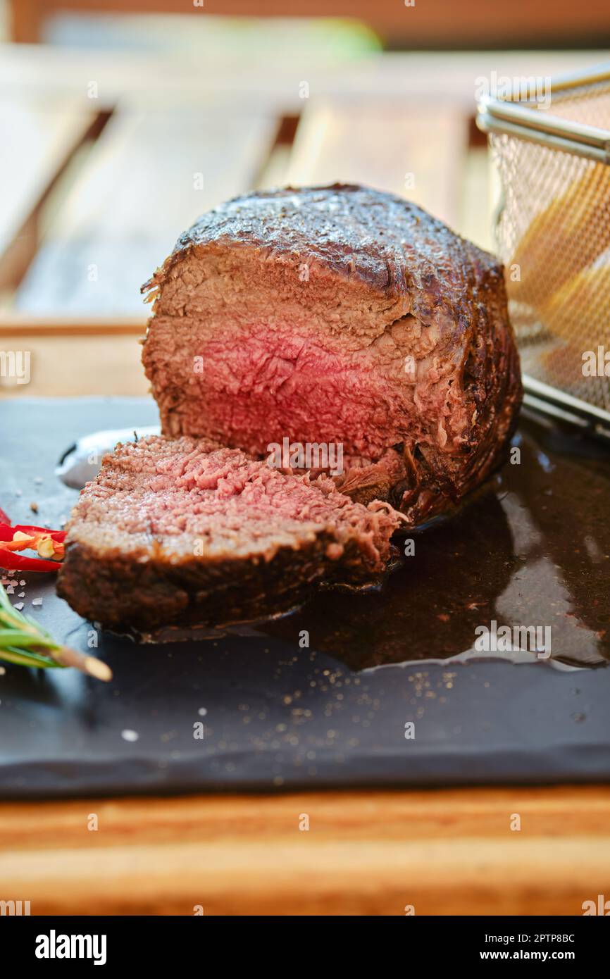 Grilled big fillet mignon beef steak cut on half Stock Photo - Alamy