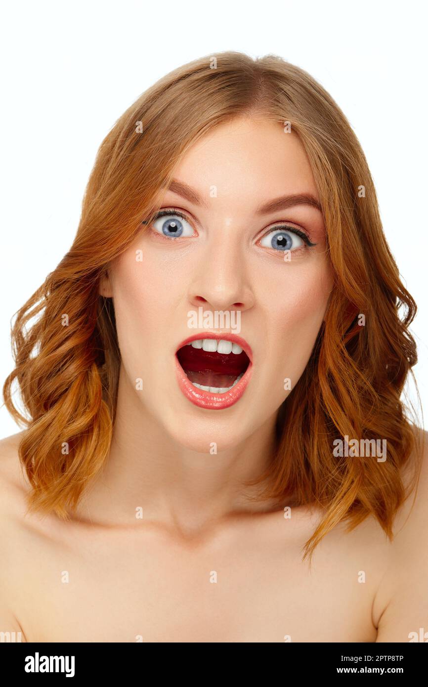 Portrait of surprised young woman with wide open mouth. Blue eyes and red lips. Beauty portrait ...