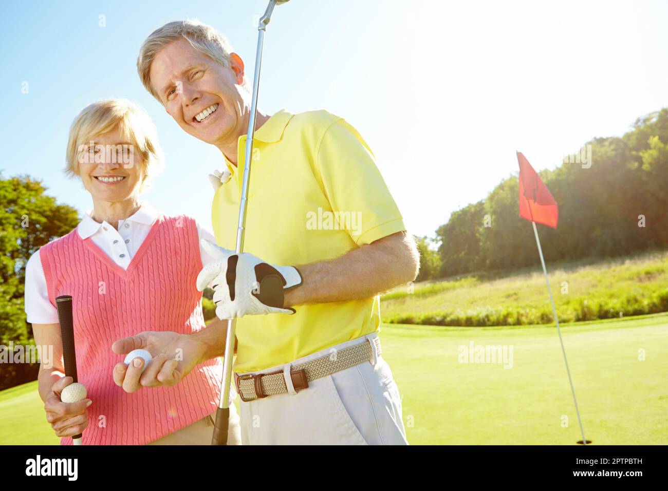 Golf keeps us bonding regularly. Elderly couple holding their golf ...
