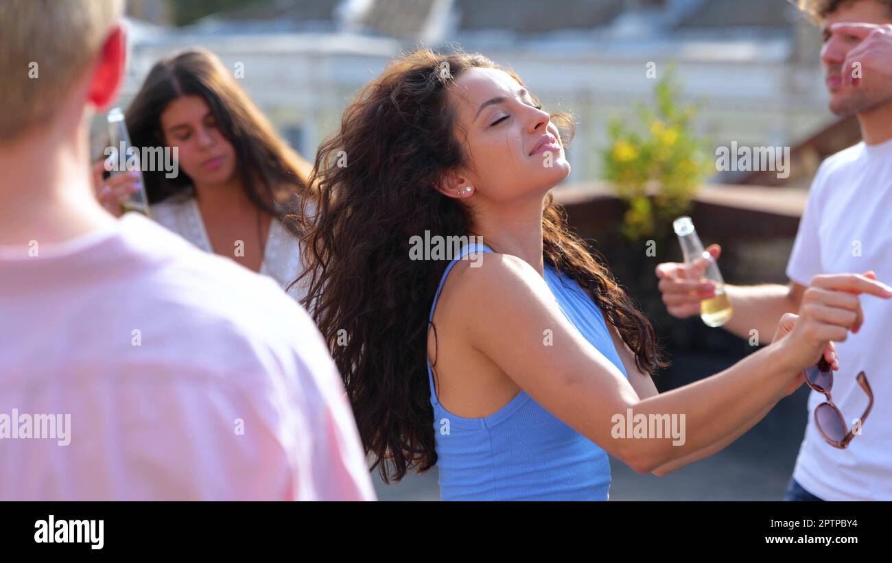 Cute woman having fun with friends at sunset disco. Close-up woman ...