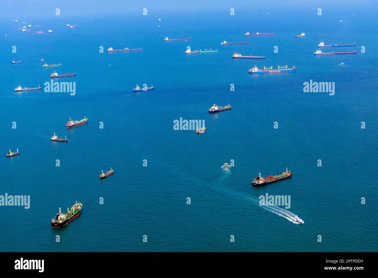 Aerial view of cargo ships queues to enter in Singapore harbor ...