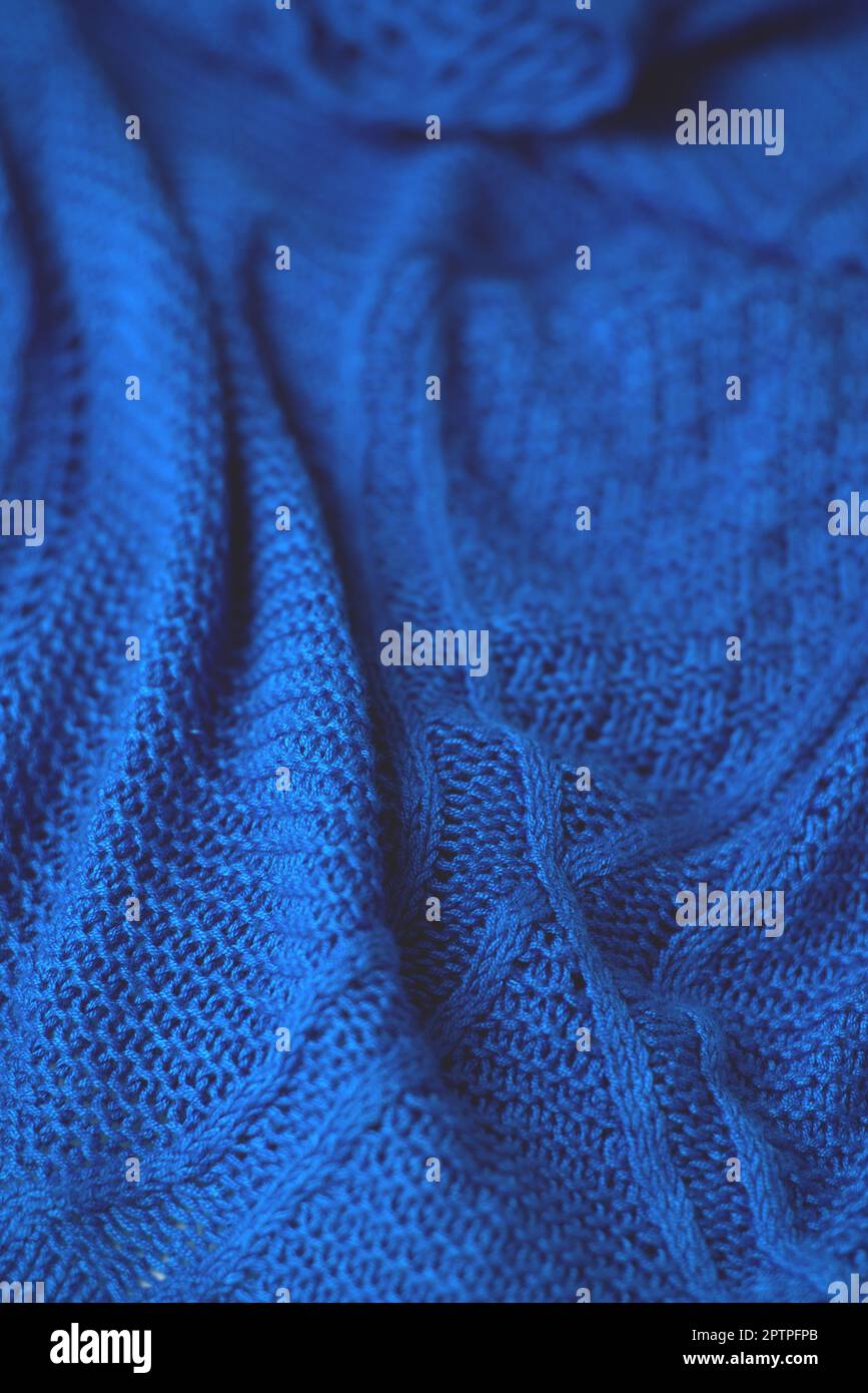Azure blue crochet sweater on white background. Texture detail close up ...