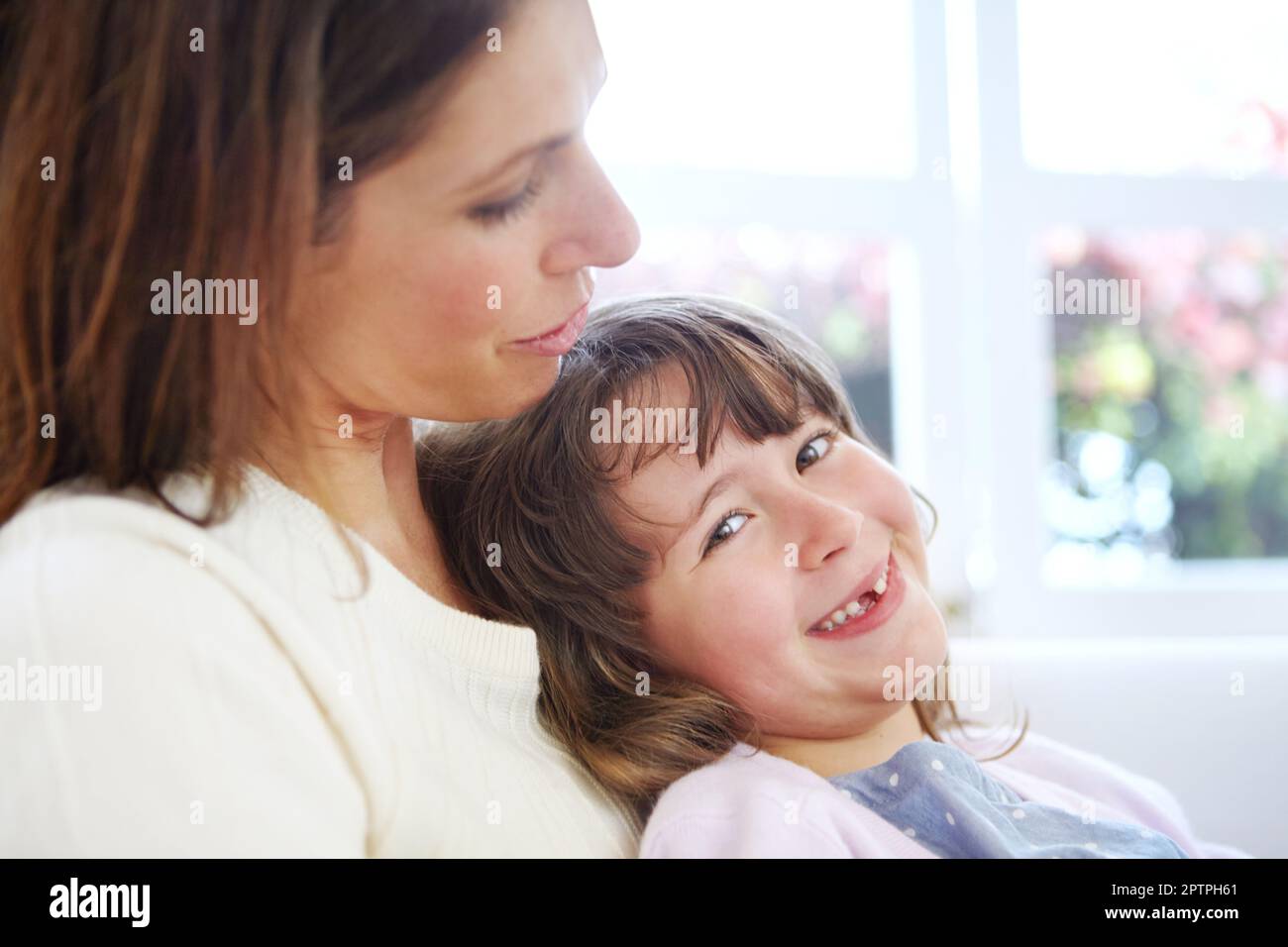 I love spending time with mom. an adorable little girl sitting on her ...