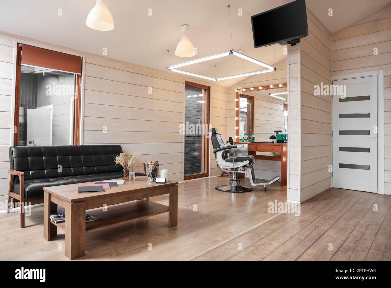 Stylish barbershop interior with hairdresser's workplace, leather sofa ...