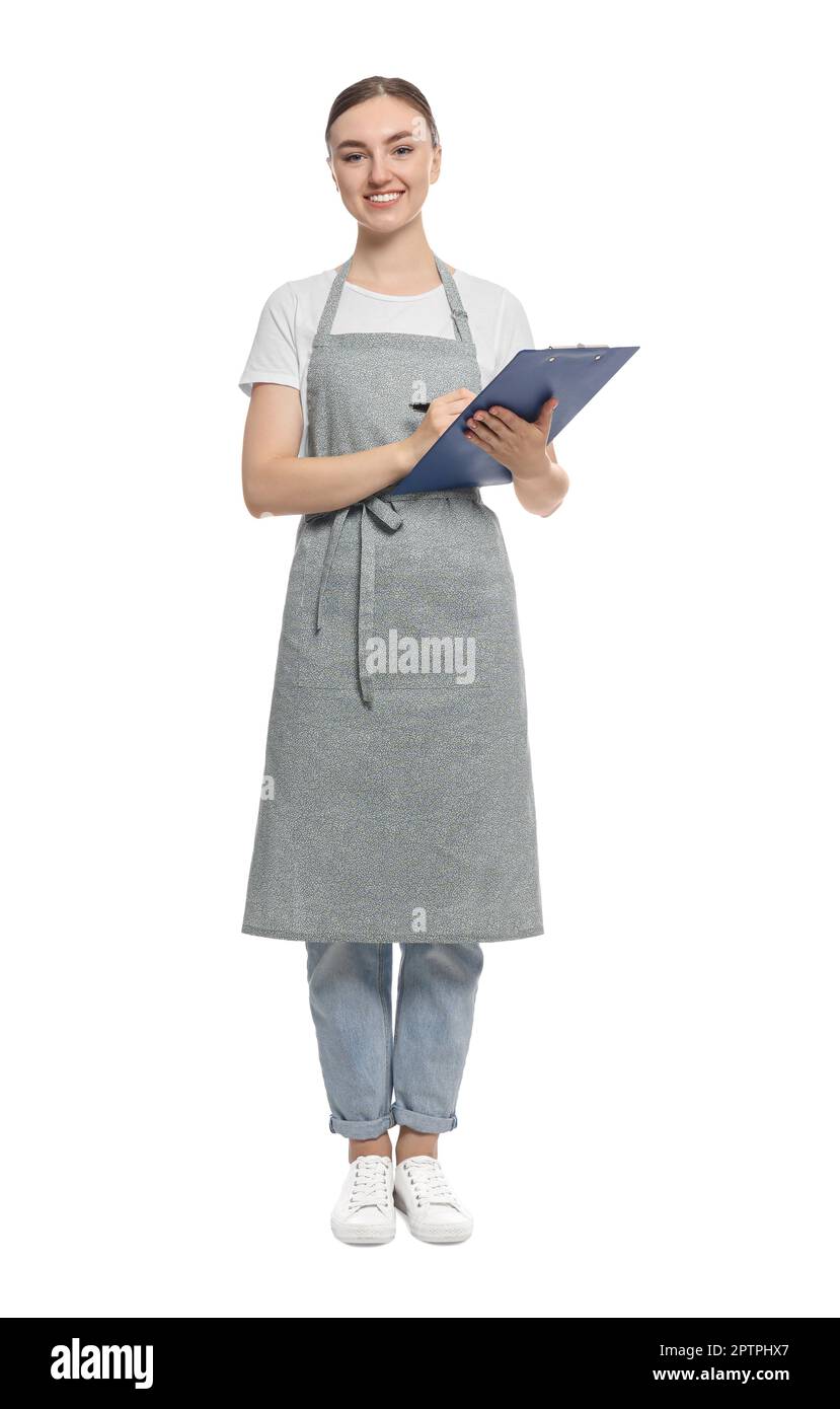 Beautiful young woman in clean apron with clipboard on white background ...