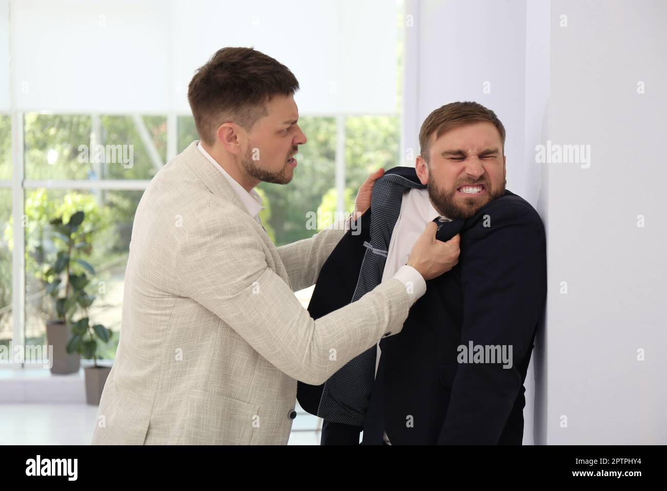 Emotional colleagues fighting in office. Workplace conflict Stock Photo ...