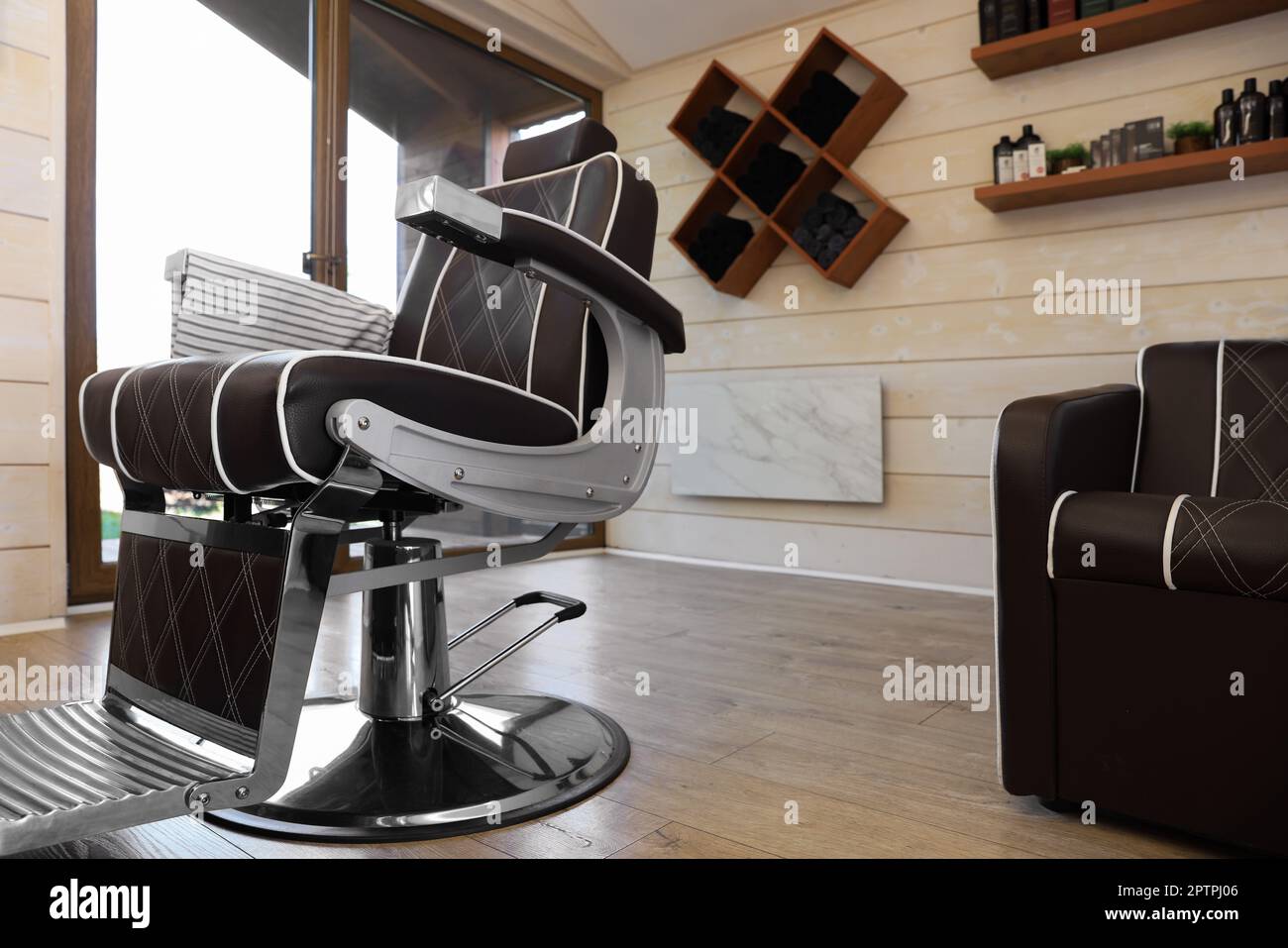 Stylish barbershop interior with professional armchair and modern wash ...