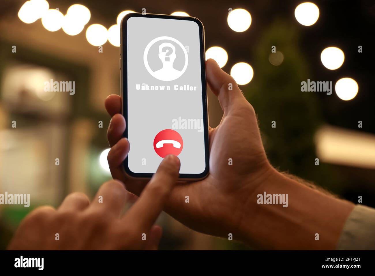 Man declining incoming call from unknown caller outdoors at night ...