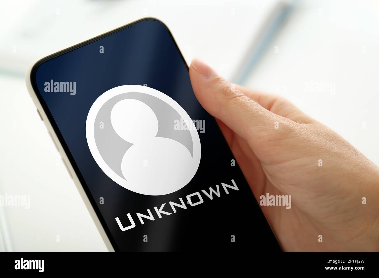Woman holding smartphone with incoming call from unknown caller against blurred background ...