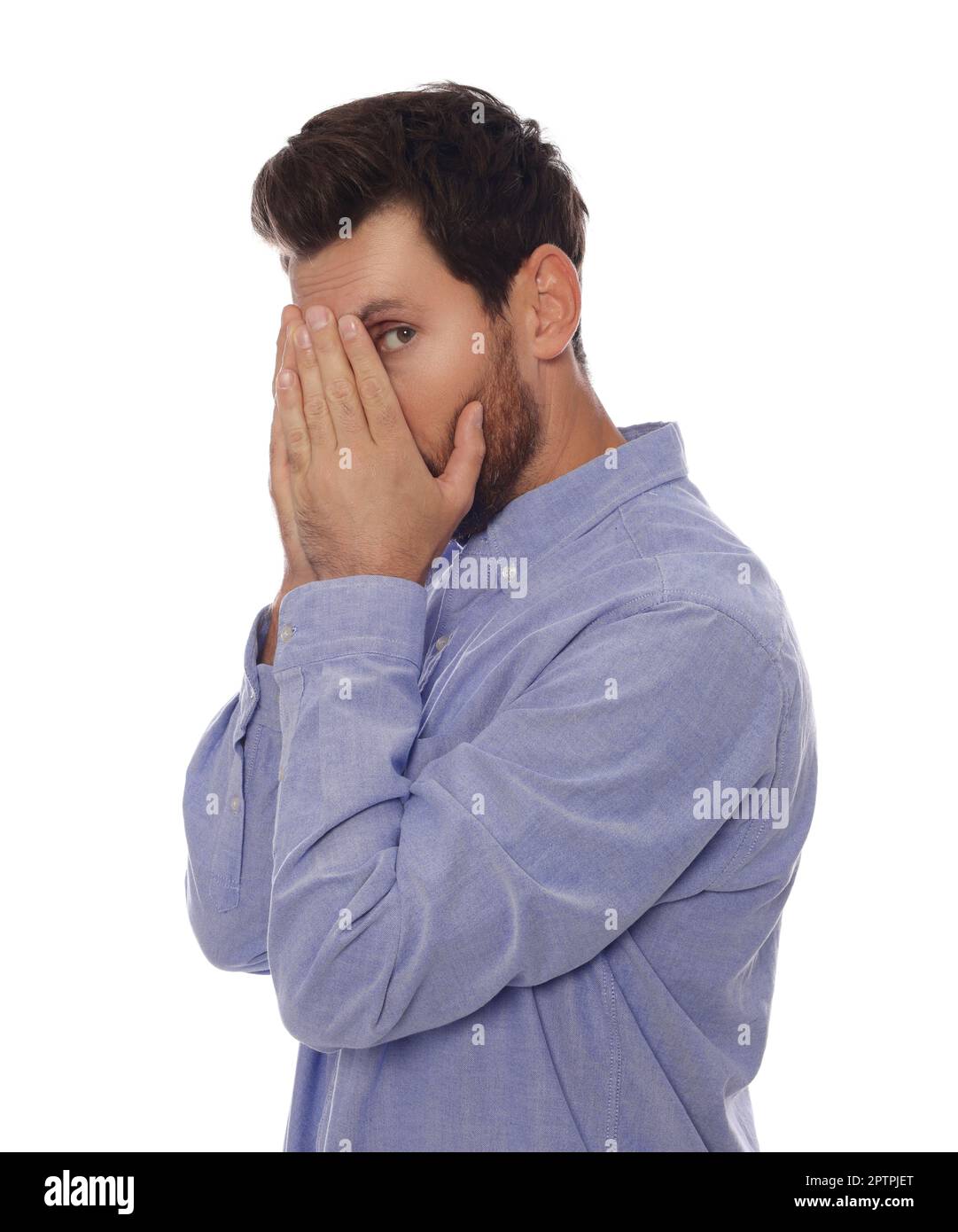 Embarrassed man covering face with hands on white background Stock ...