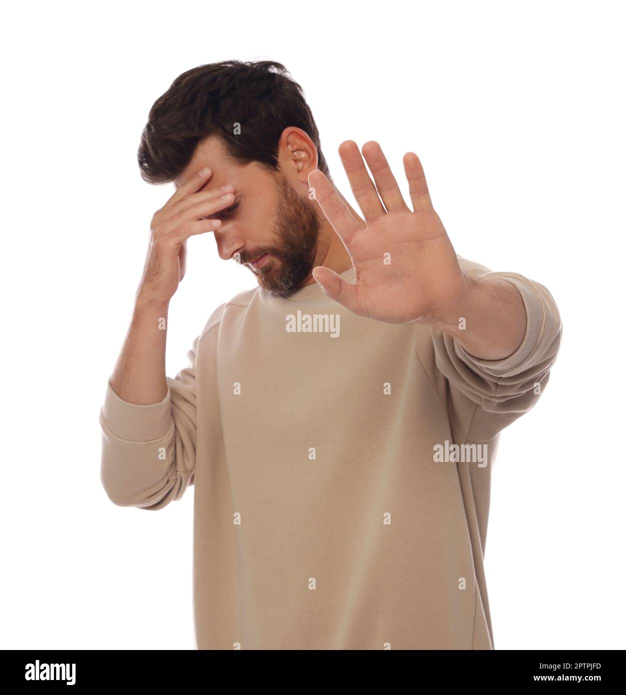 Embarrassed man covering face with hand on white background Stock Photo ...