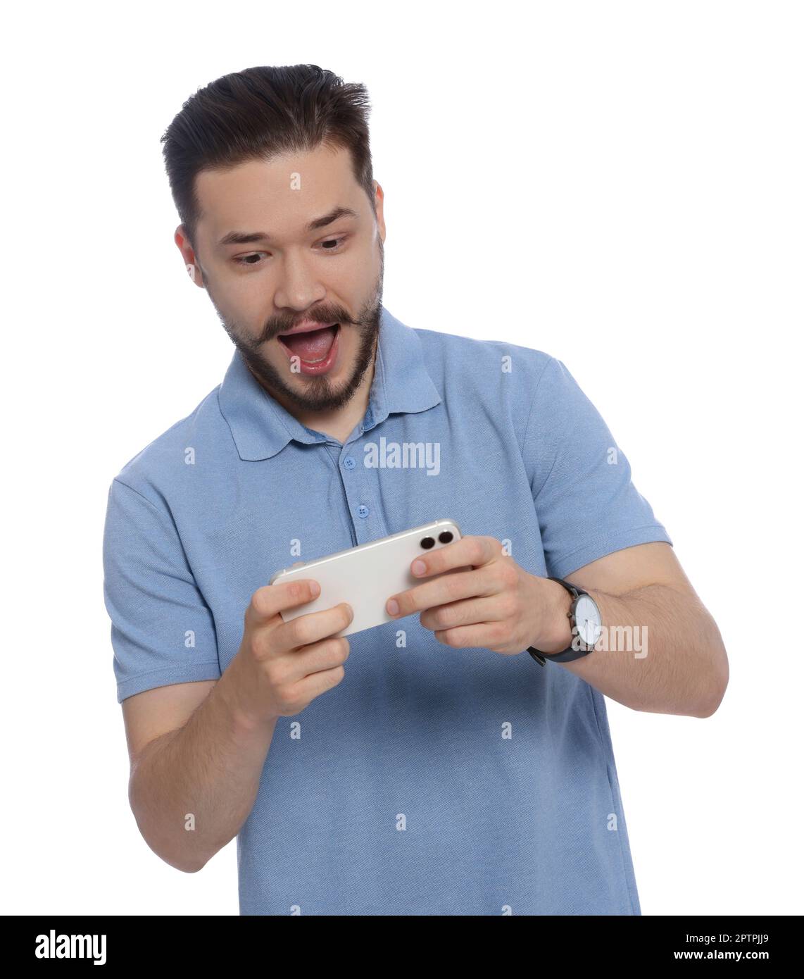 Emotional man playing game on phone against white background Stock ...