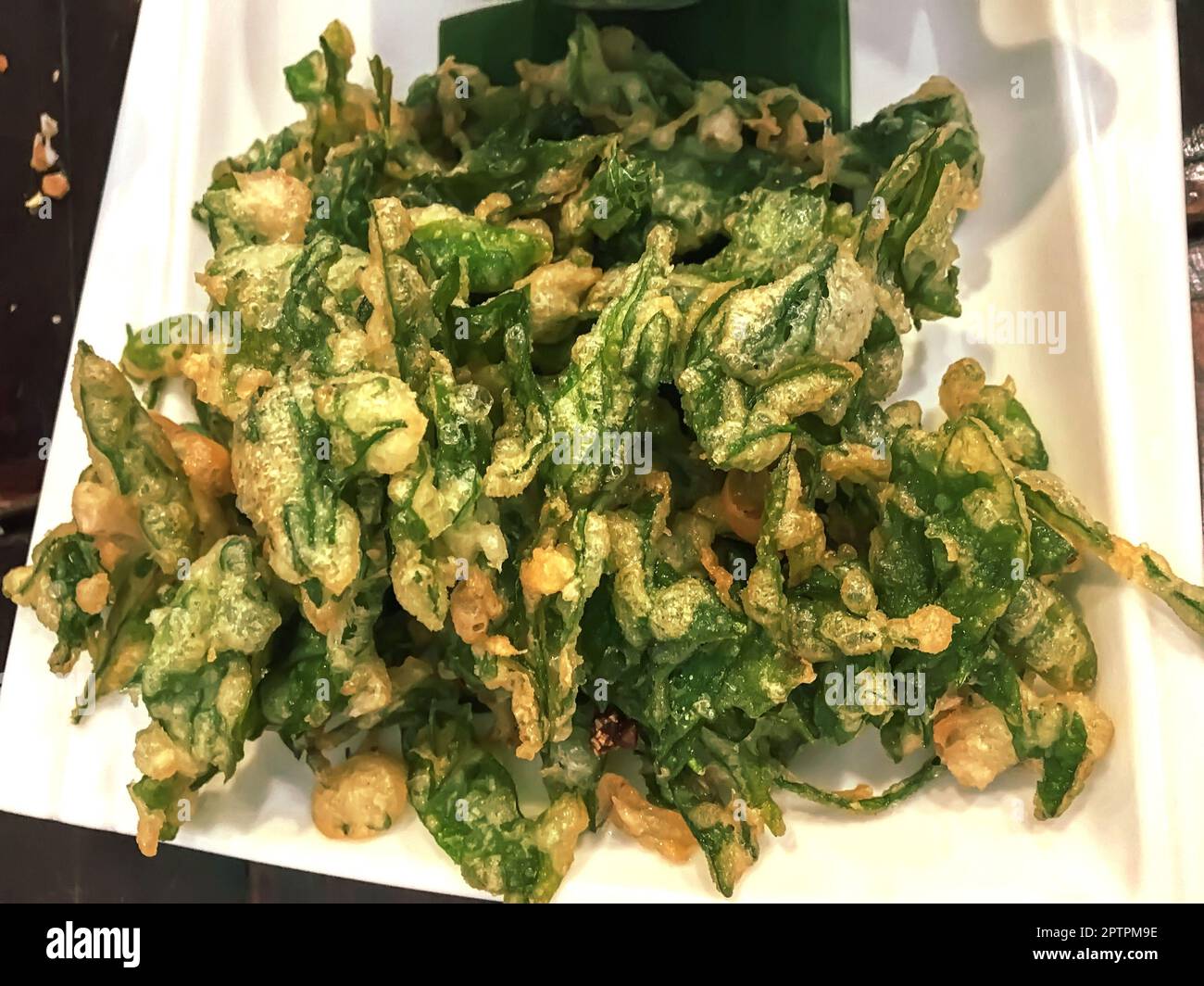 Crispy morning glory salad in a white plate Stock Photo - Alamy