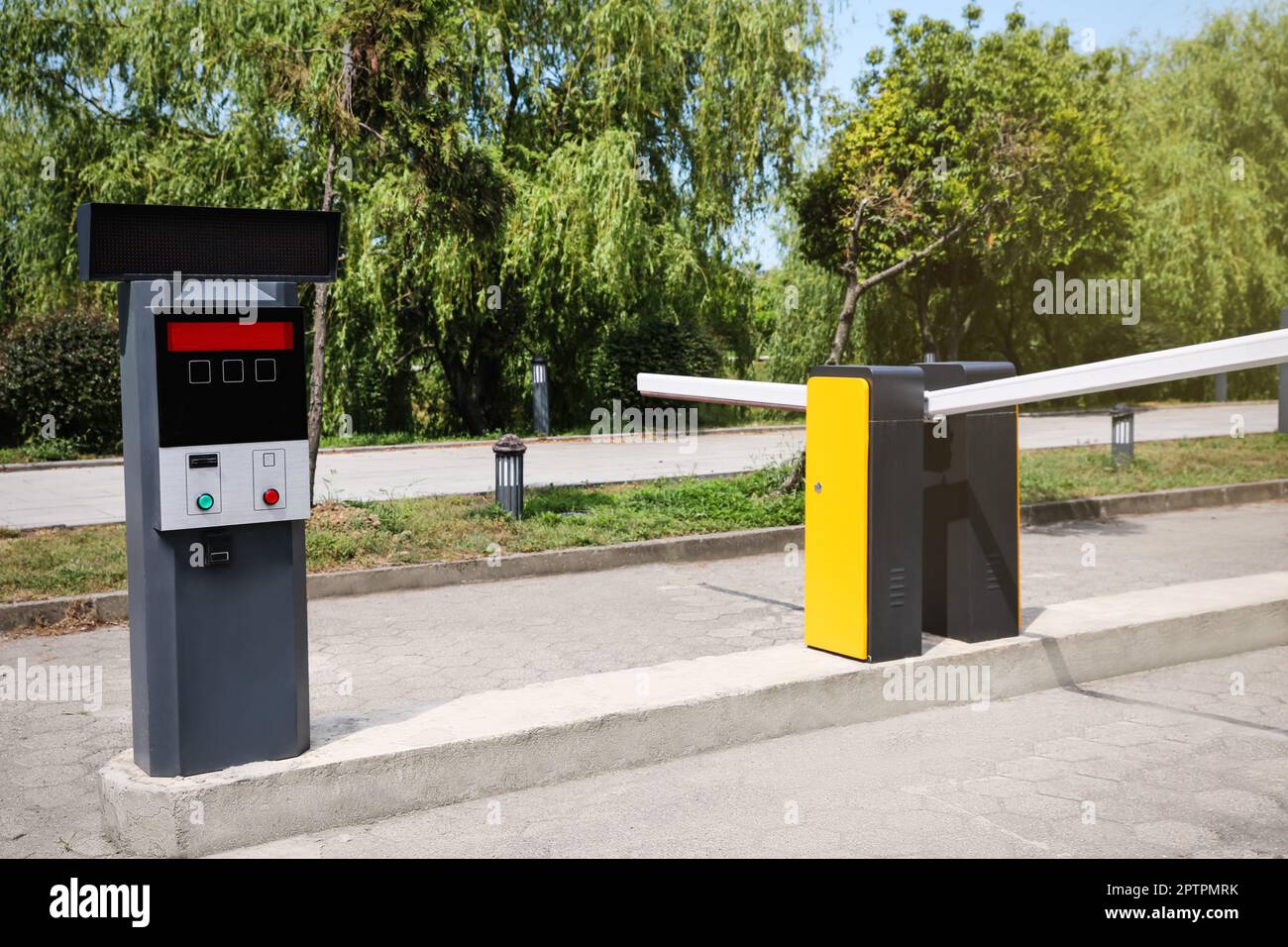 Modern road barriers and parking meter outdoors on sunny day Stock ...