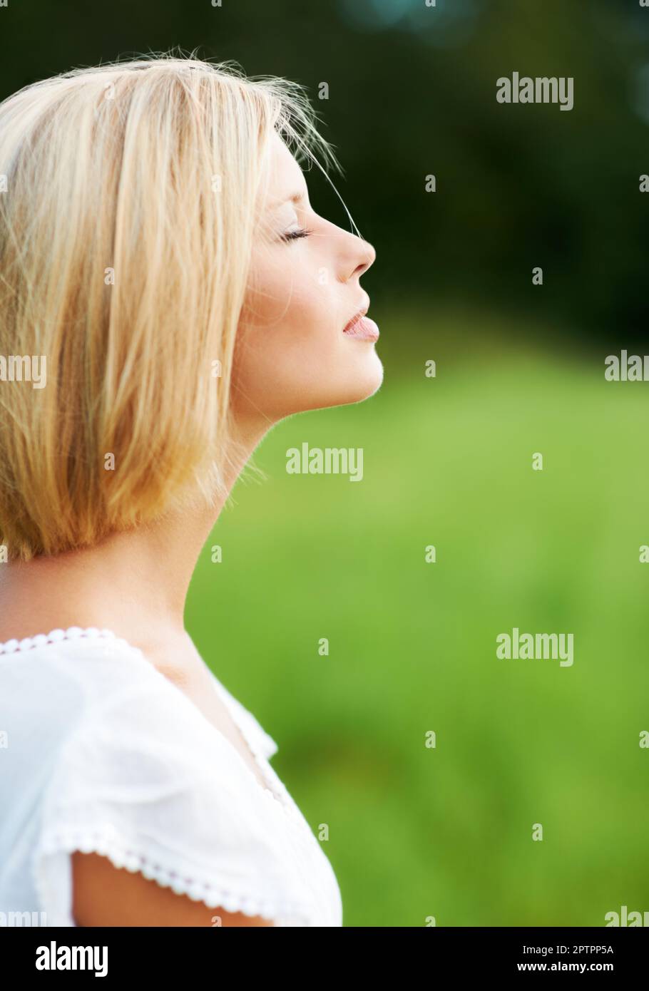 Enjoying the harmony of nature. Lovely young woman savoring the breeze ...