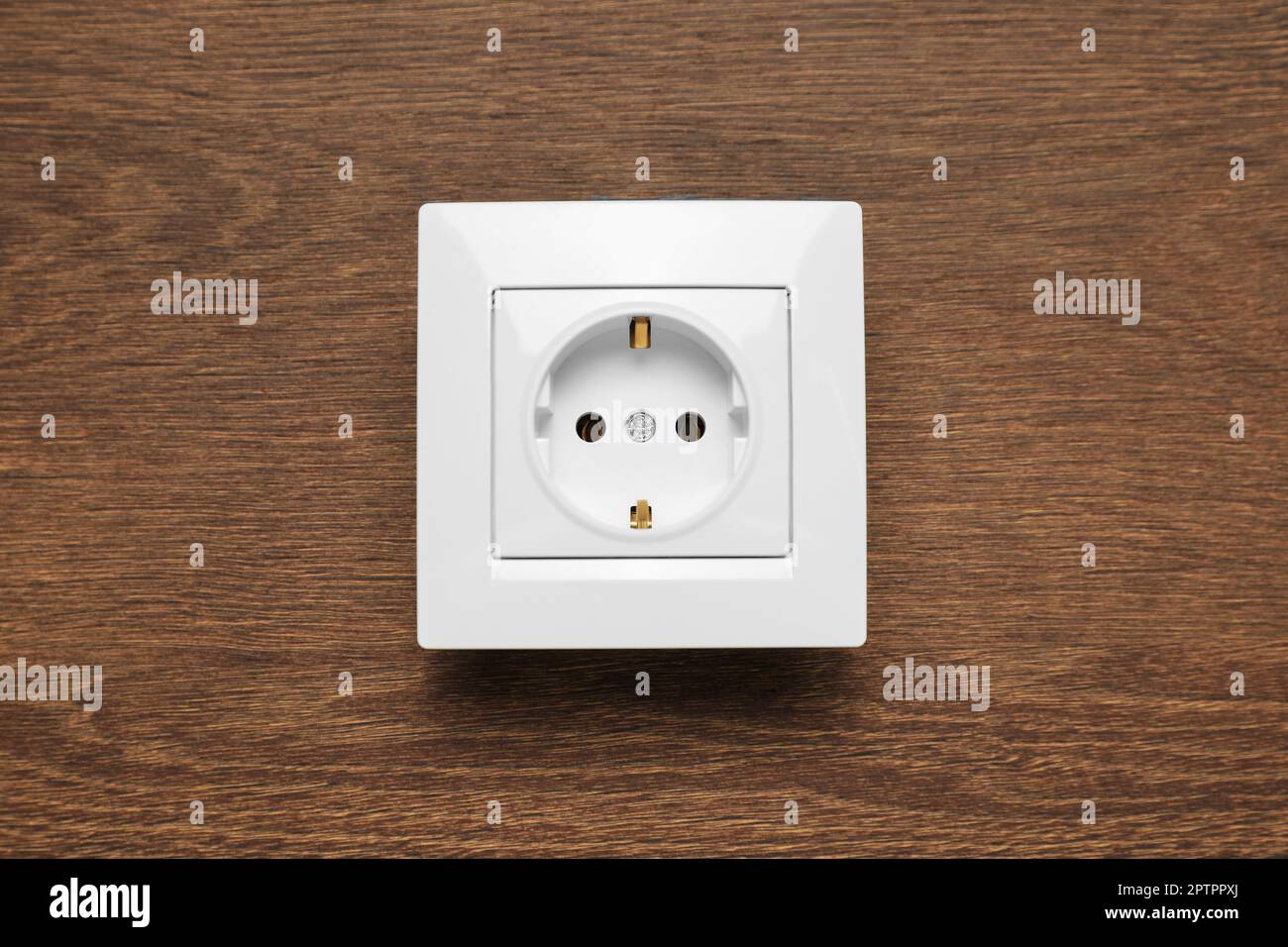 Modern plastic power socket on wooden table, top view Stock Photo - Alamy