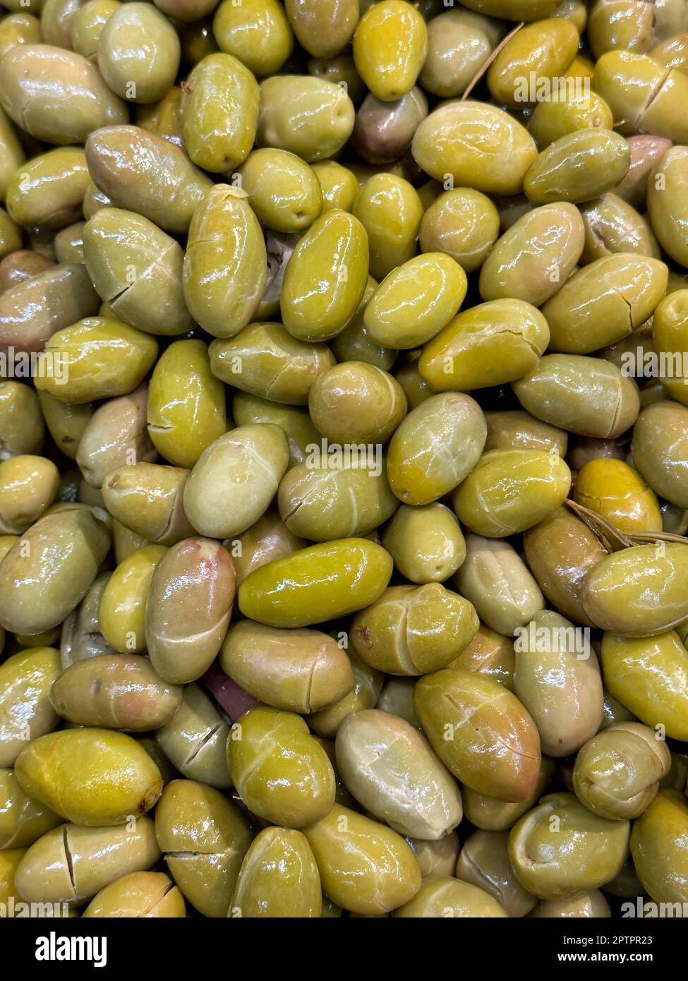 Green olives. Heap of organic olives. Close up. Food background. Top ...