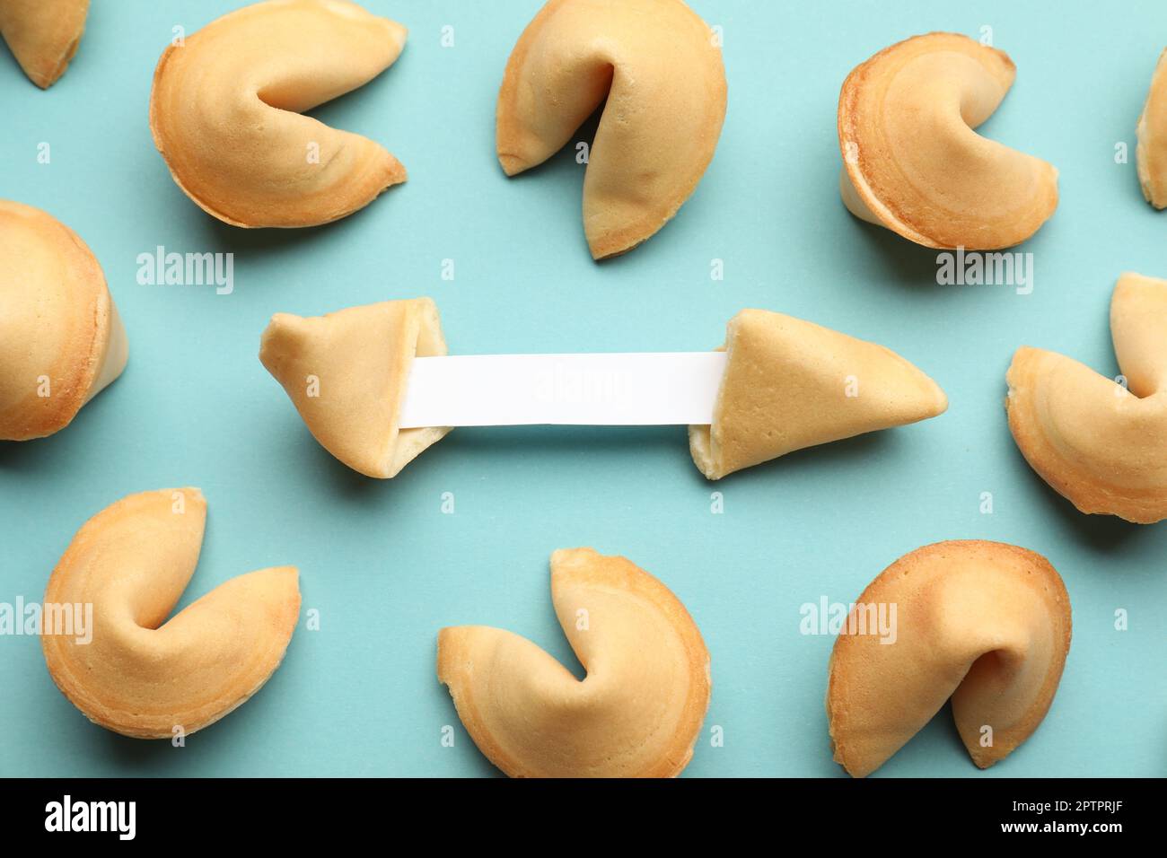 Tasty fortune cookies with predictions on light blue background, above ...