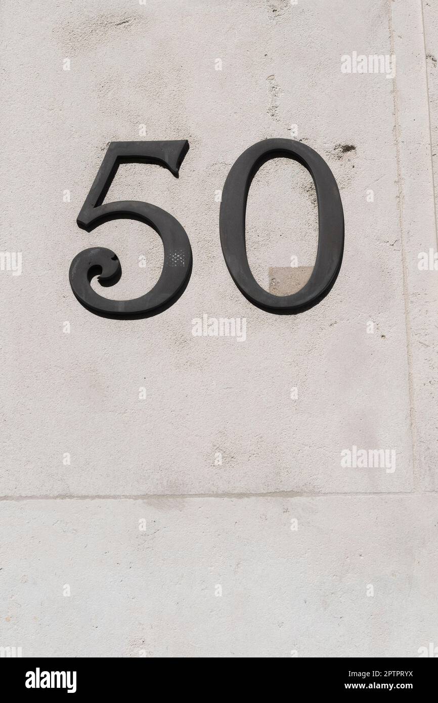 Number fifty one in dark figures on white stone wall Stock Photo - Alamy