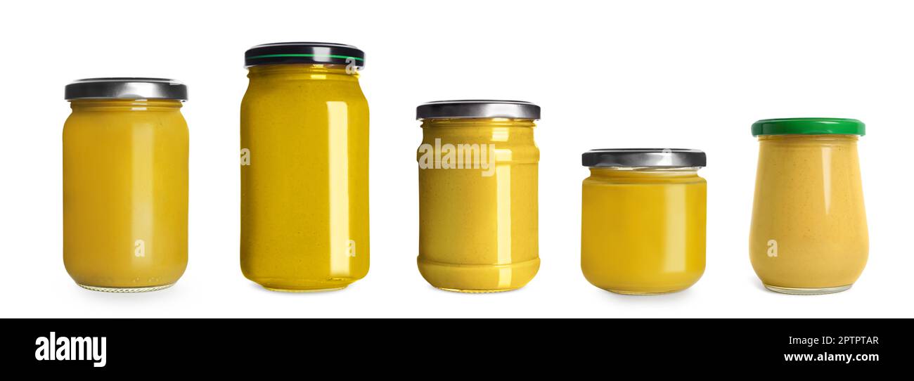 Set with different glass jars of spicy mustard on white background ...