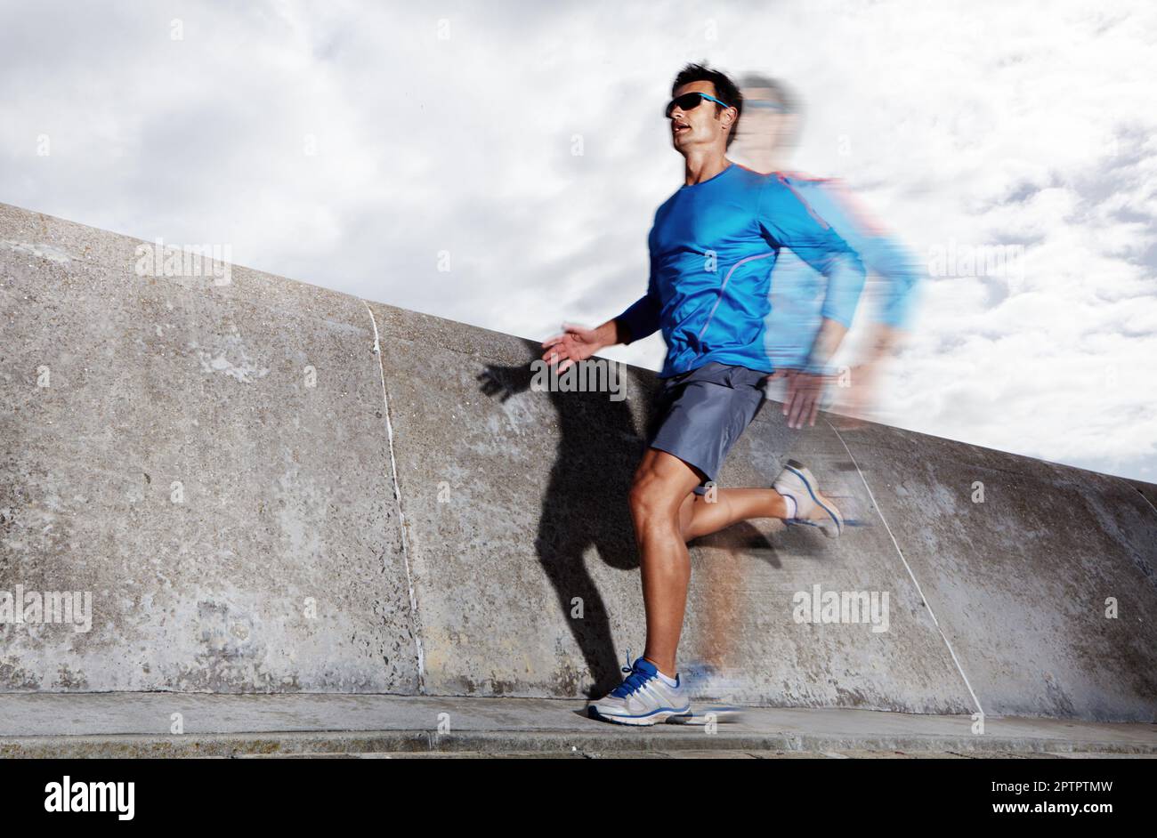 Running on adrenaline. Action shot of a sporty young man running ...