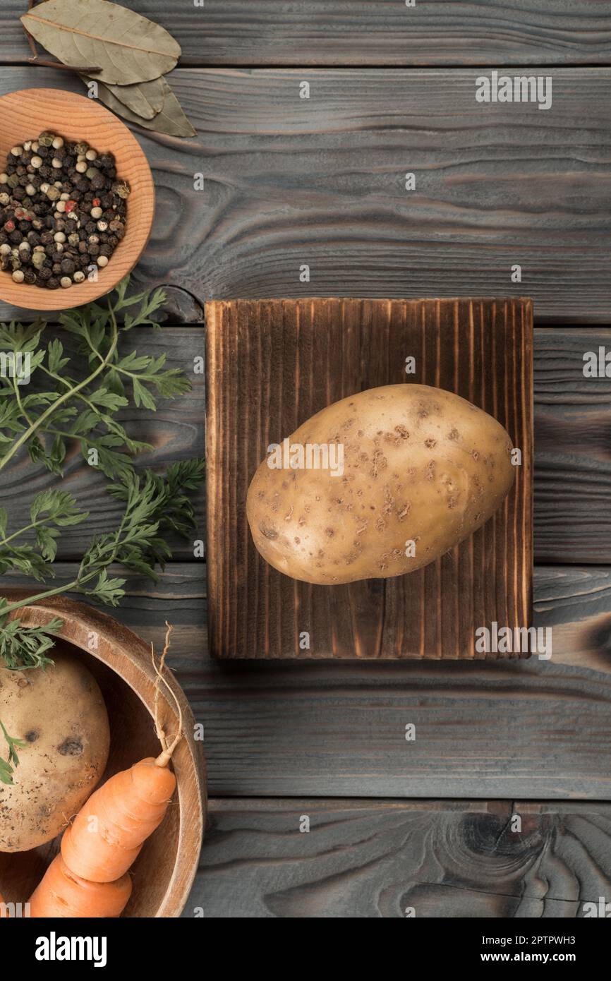 Big yellow potato on kitchen wooden board. Flat lay view. Fresh raw ...