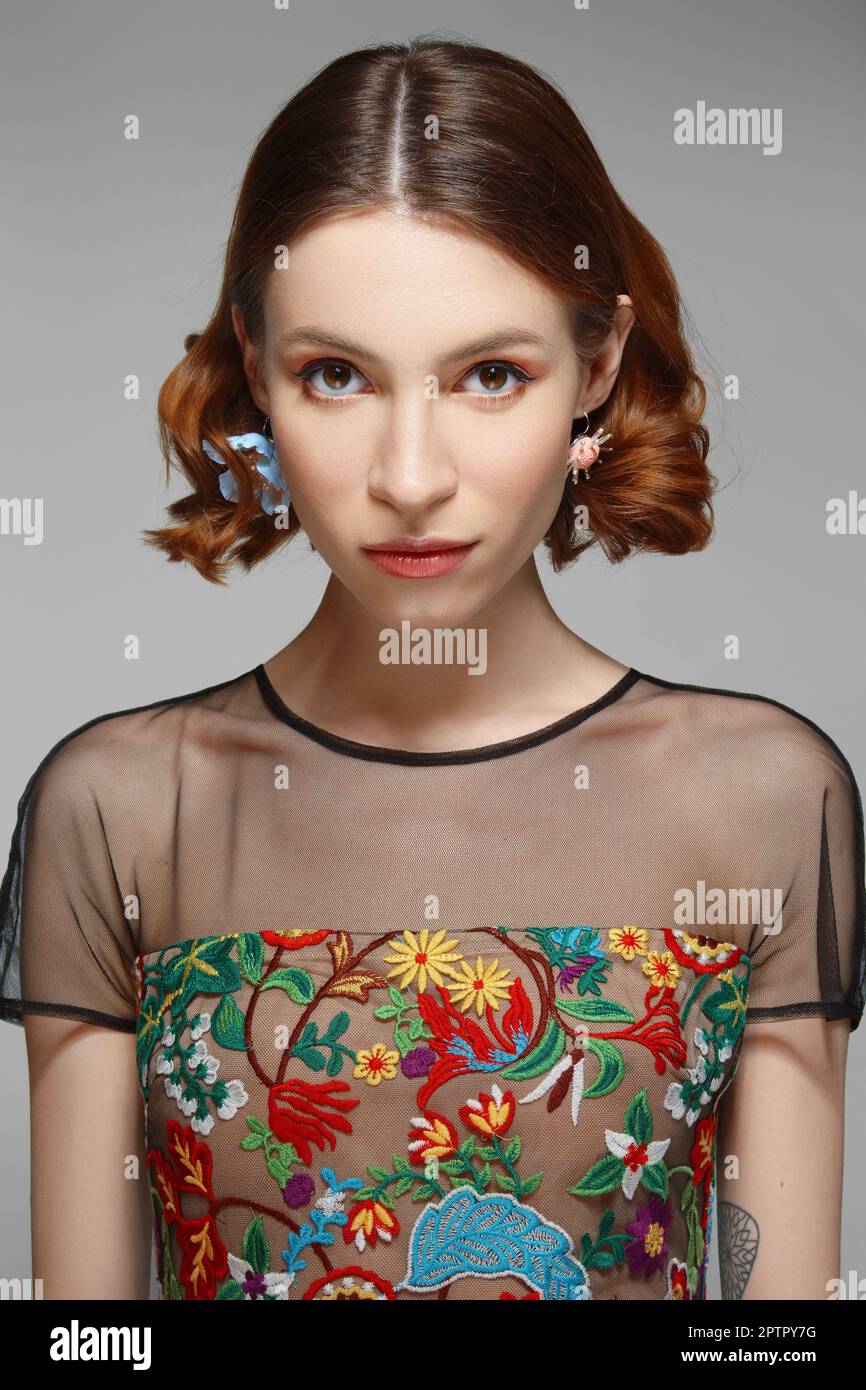 Charming girl in transparent blouse and colorful corset with natural ...