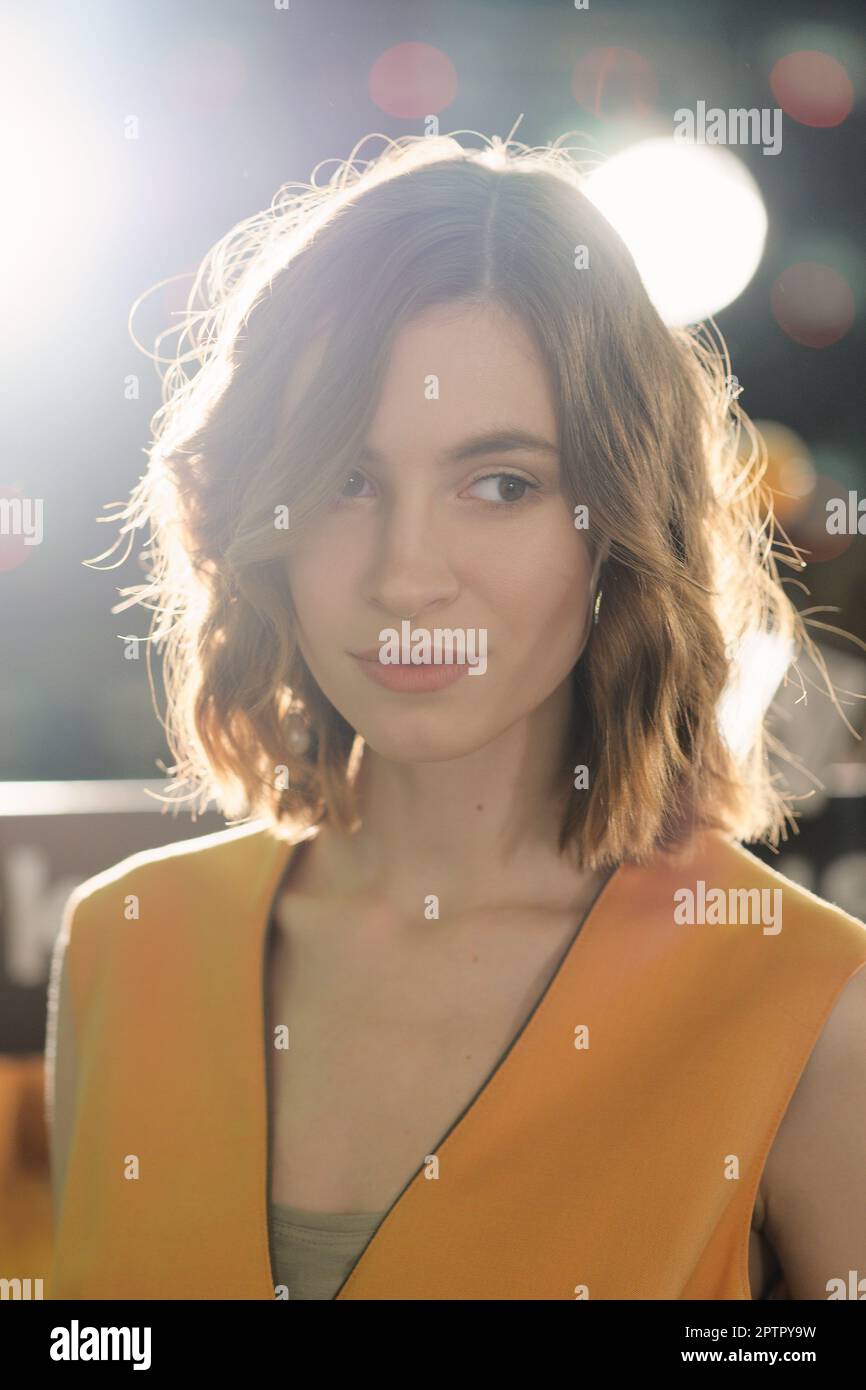 Portrait of dreamy pretty girl in yellow vest with natural makeup with ...
