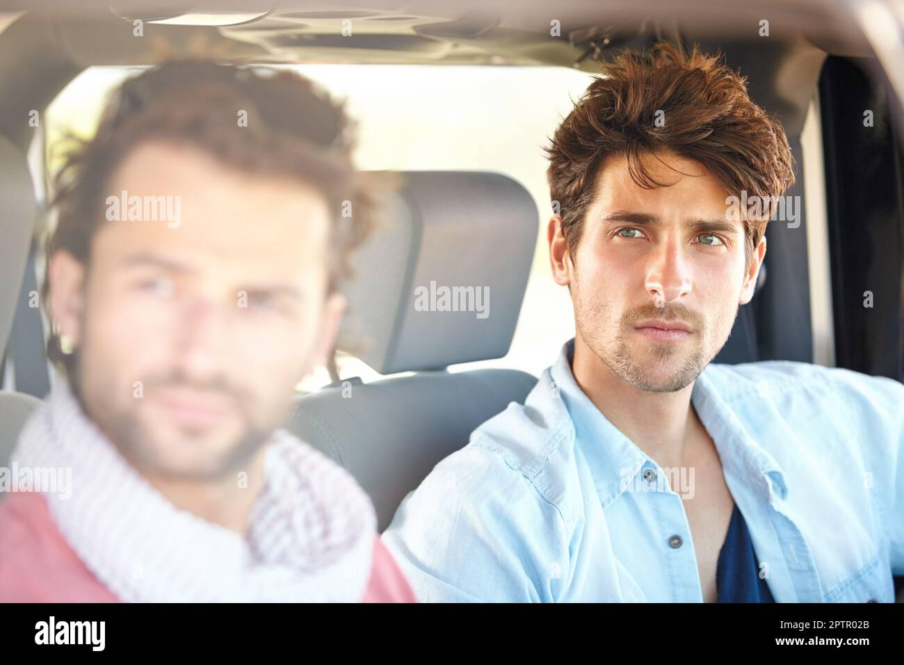 On the road again. Two friends driving together while on a road trip ...