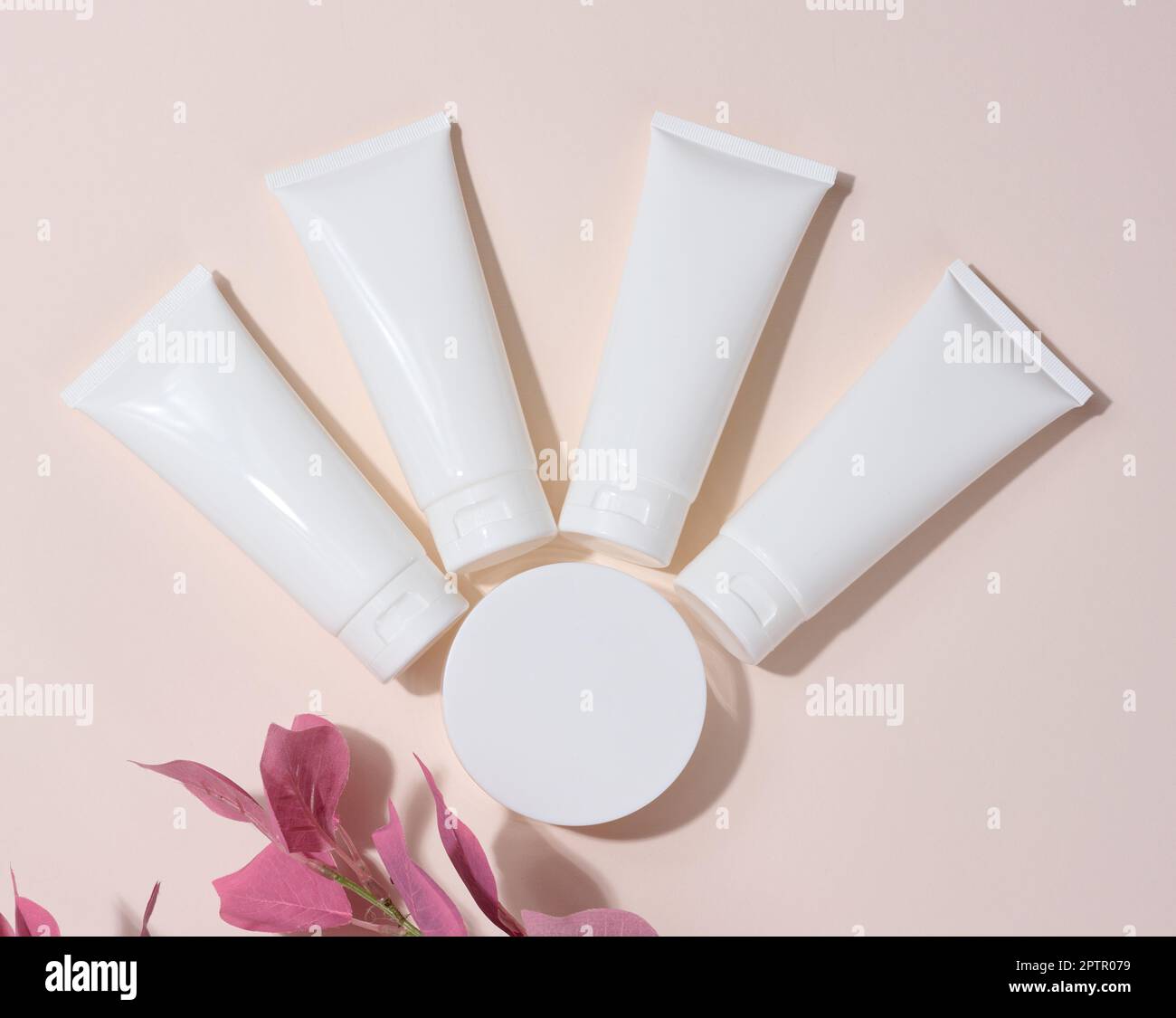 White plastic tubes, jars and other form of packaging for cosmetics on ...