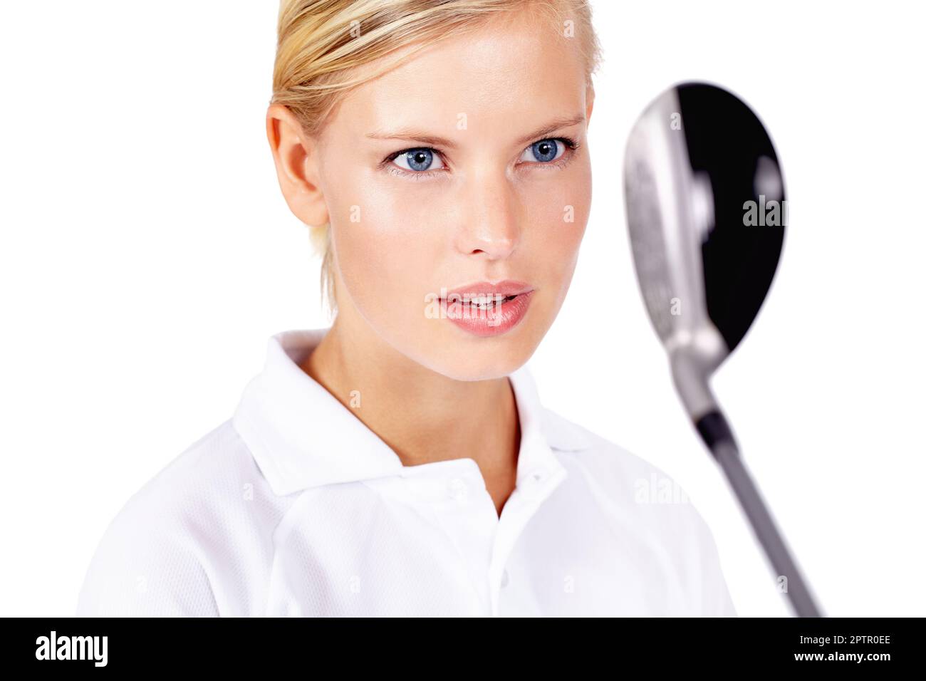 Focused on her game. Studio shot of an attractive young golfer staring ...