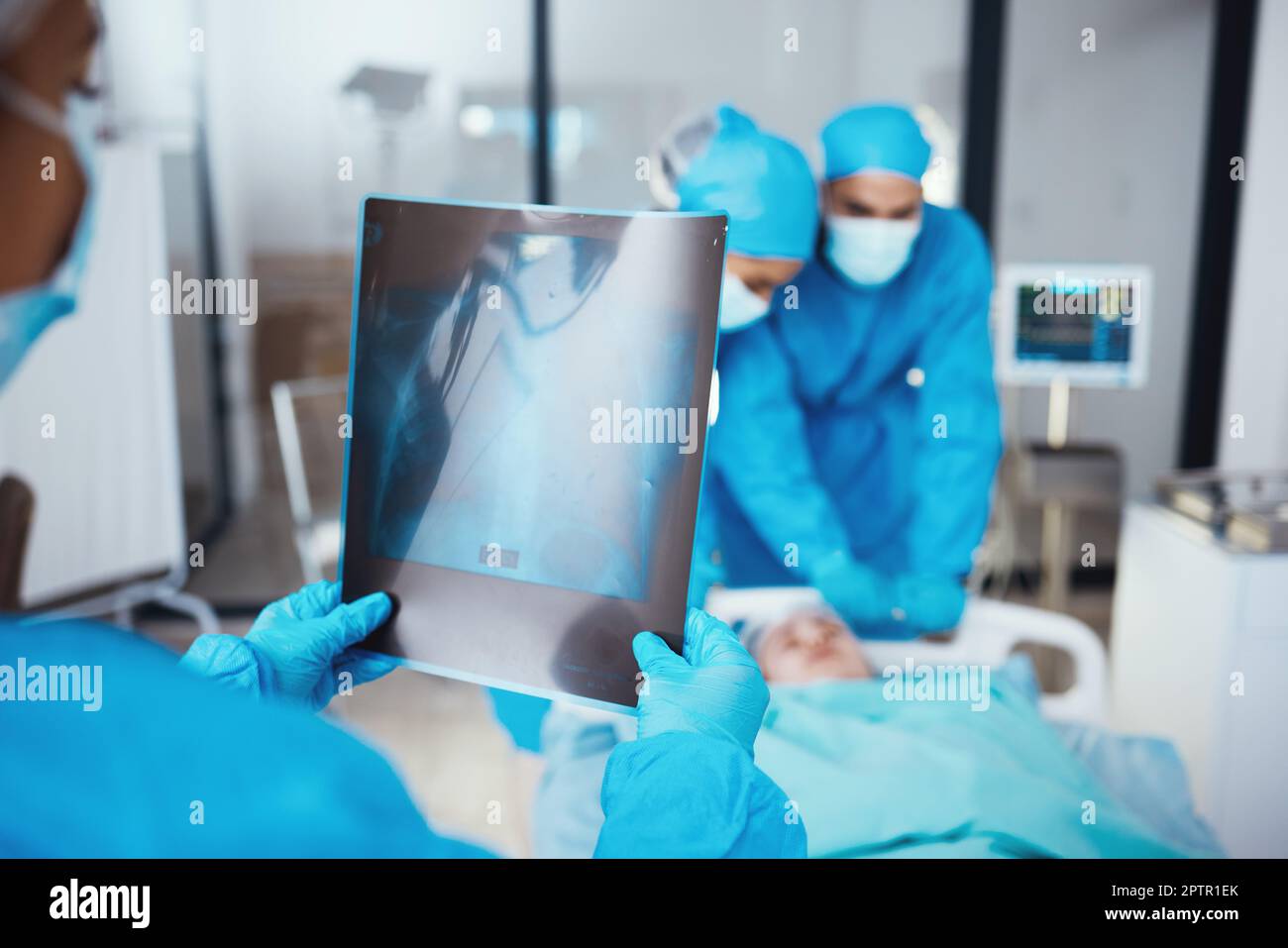 Team of doctors, x ray and surgery in hospital with patient in ...