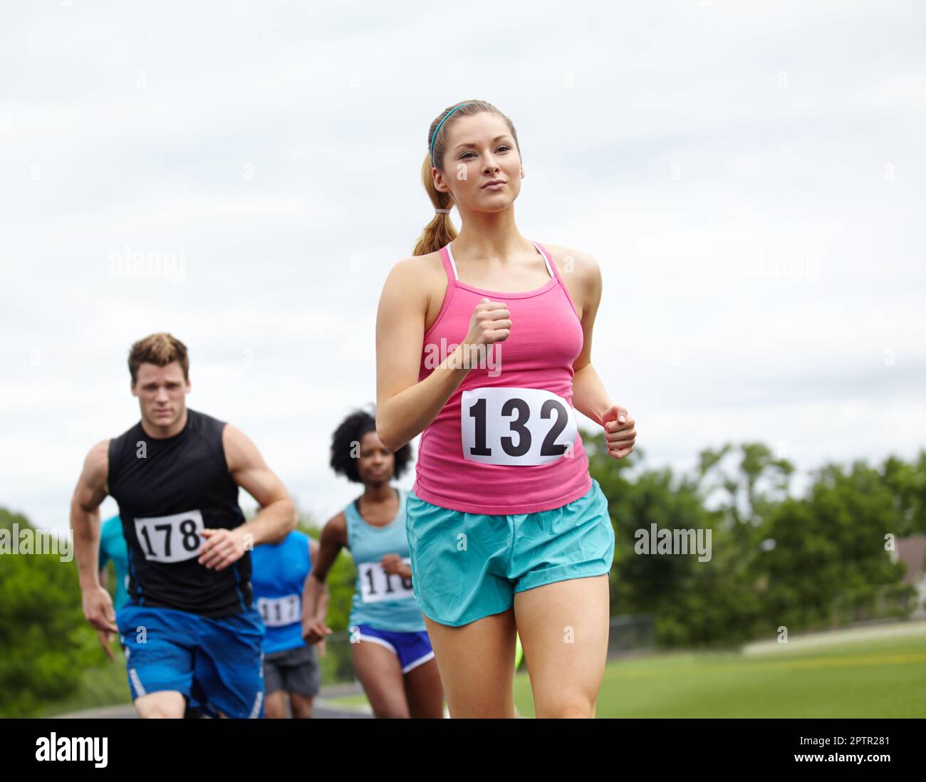 Enjoying the marathon. Front view of a determined female runner in ...