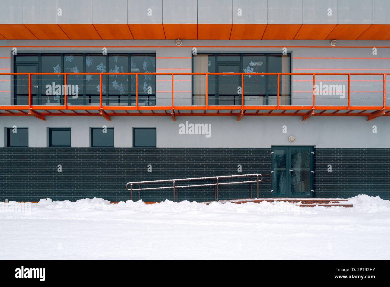 Public building entrance with a ramp for disabled person wheelchair. A ...