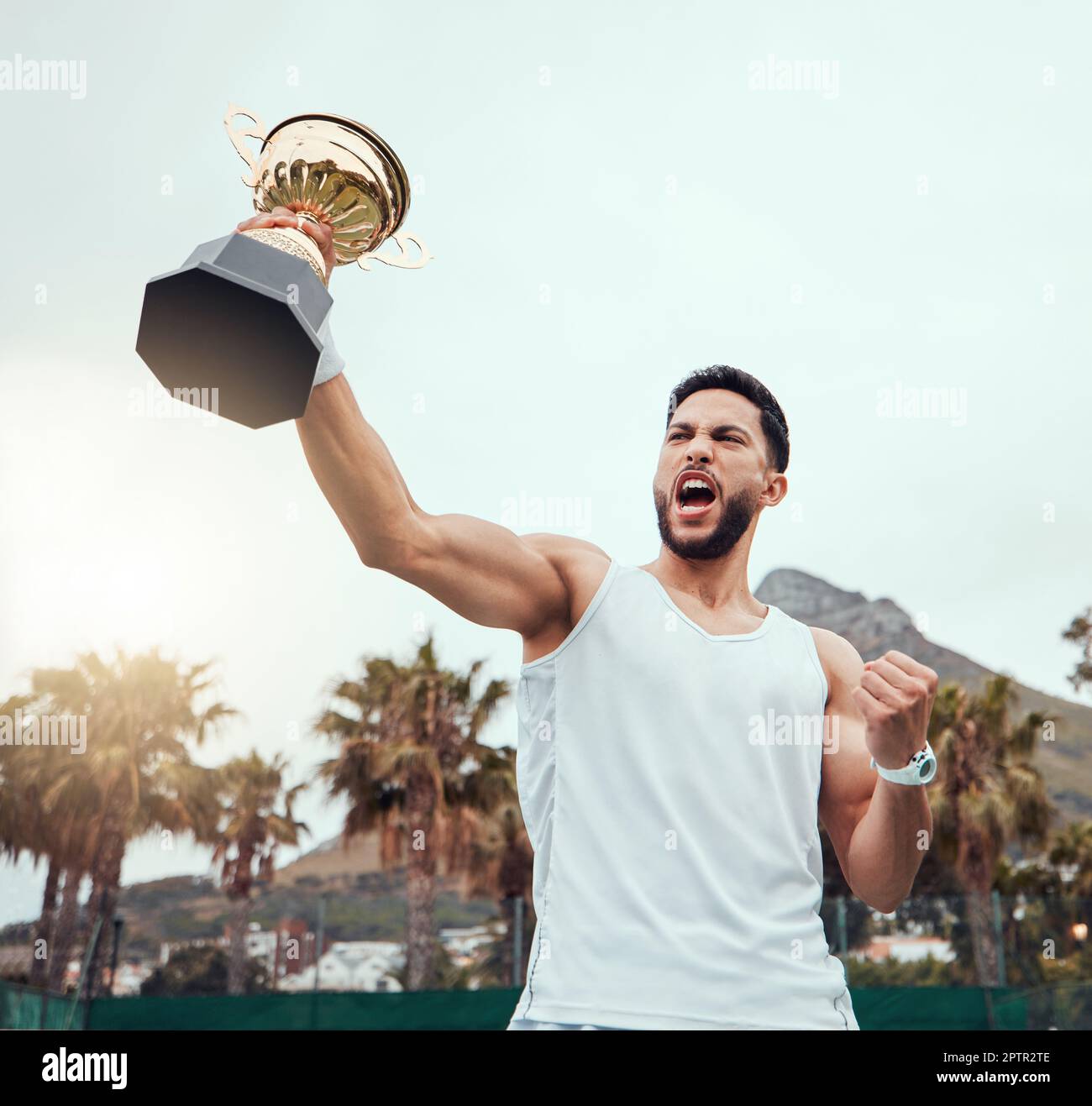 Mixed race tennis player holding trophy and celebrating success after ...