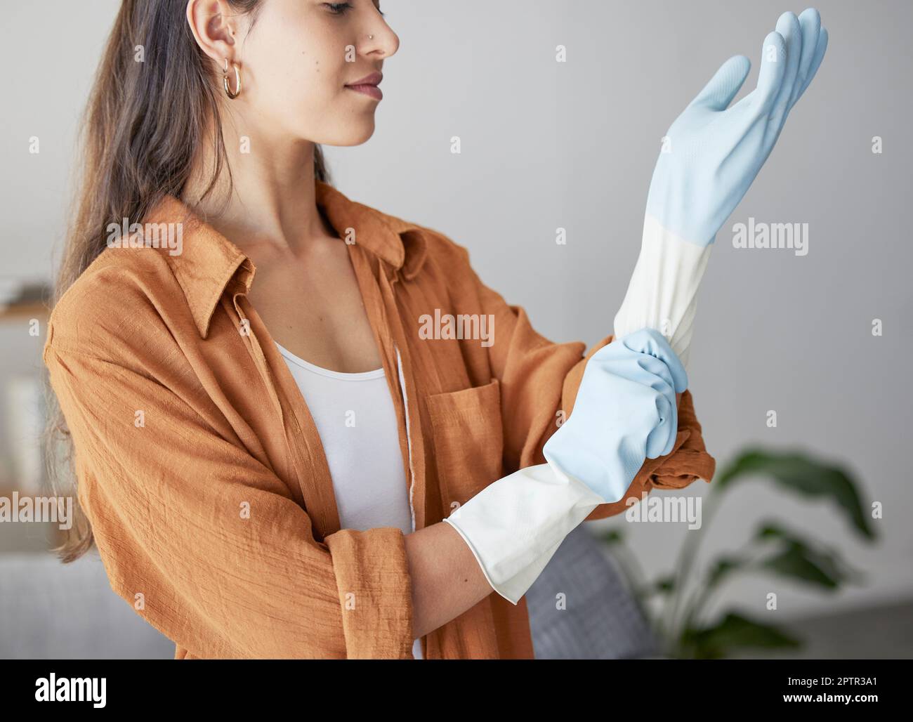 Cleaning, rubber gloves and woman in living room for housekeeping ...