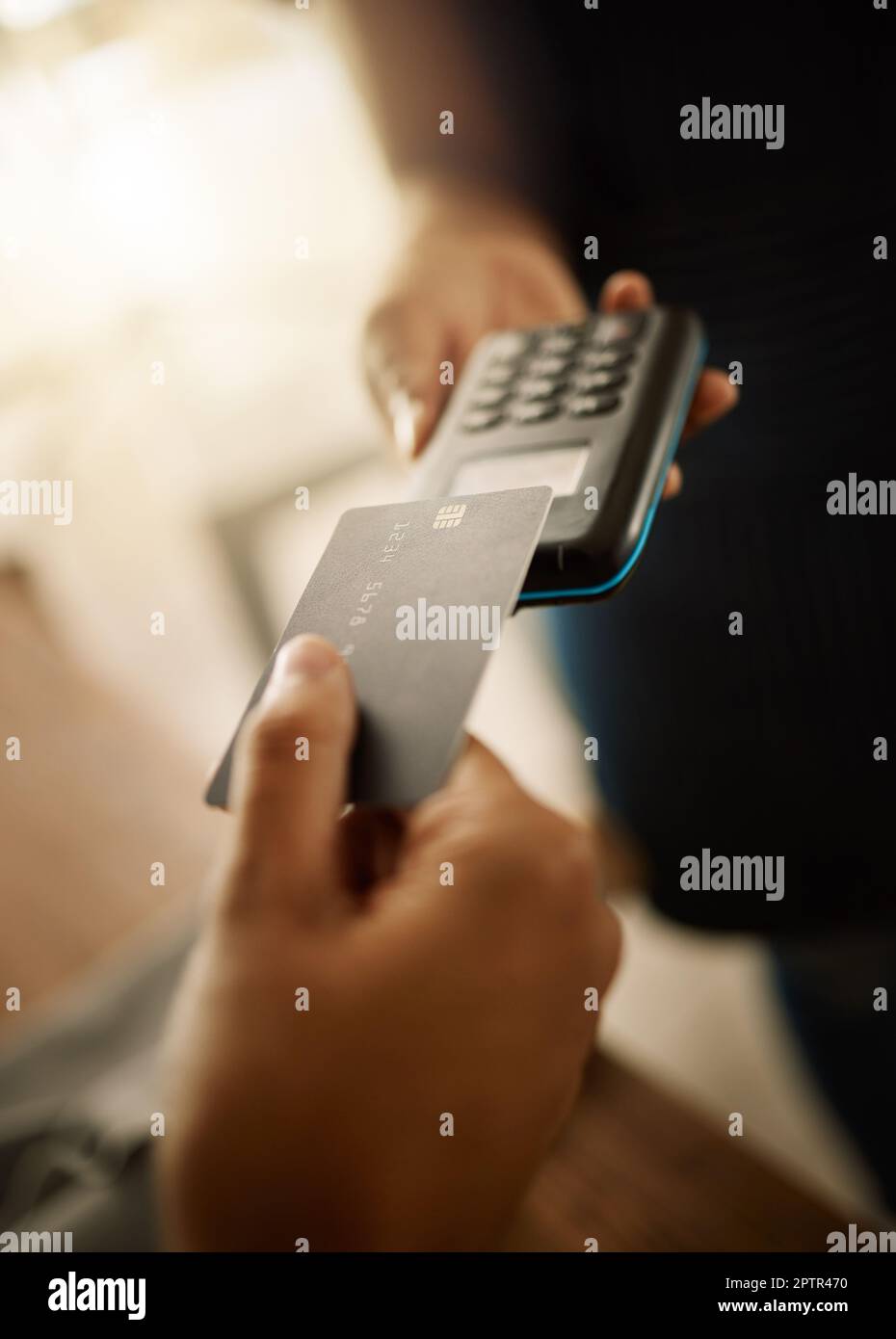 Designer accepting card payment using an nfc machine. Customer tapping ...