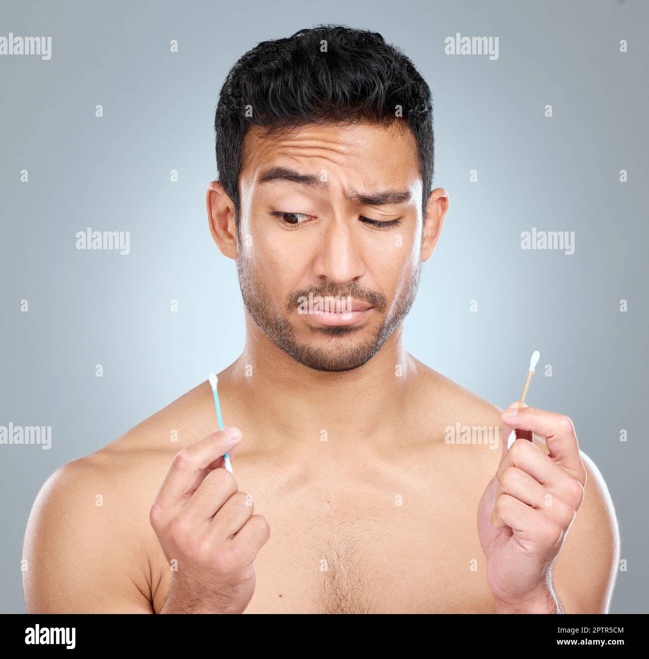 Is there even a difference. a man deciding between two cotton buds ...